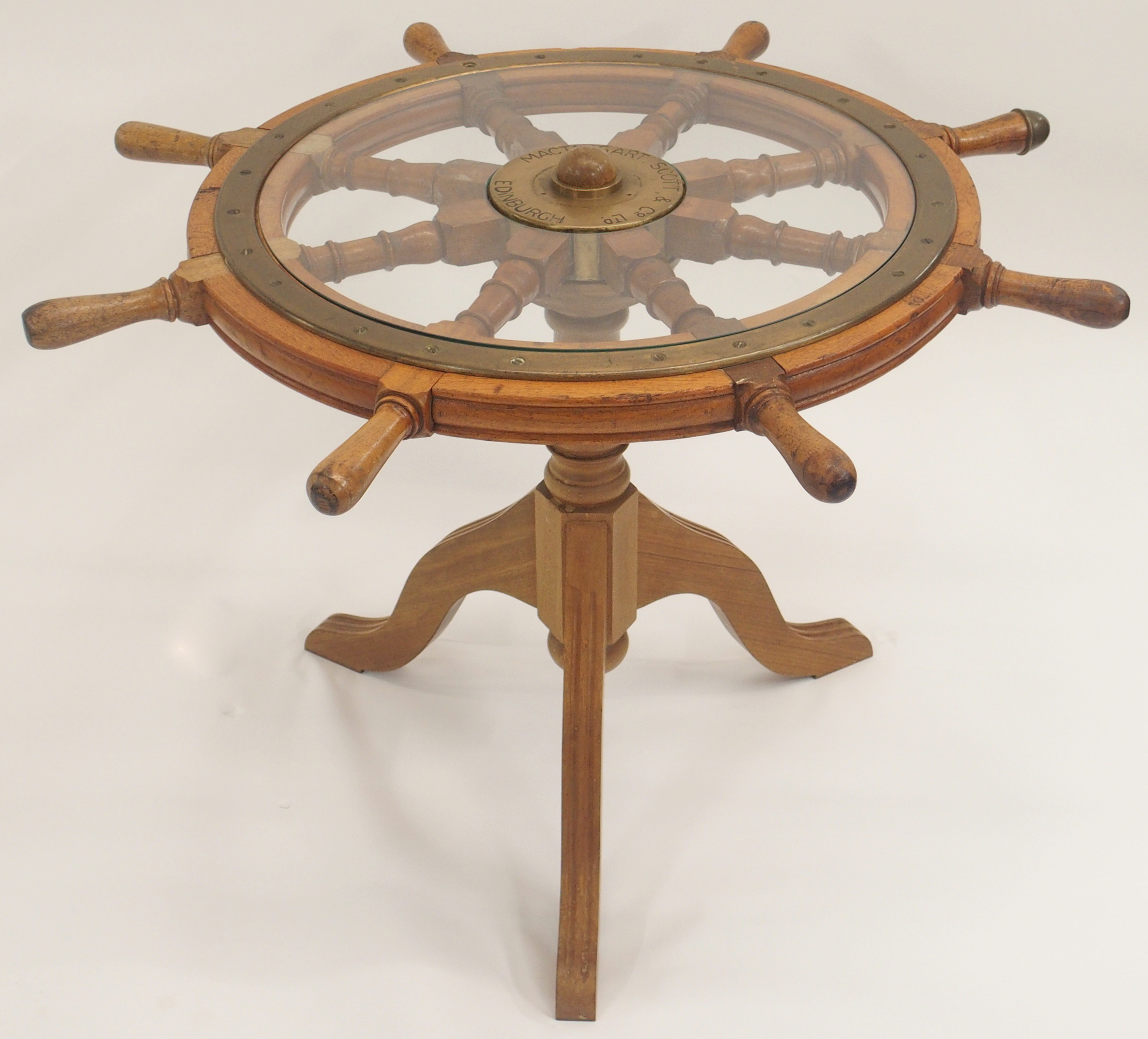 AN OAK AND BRASS MOUNTED SHIPS TELEMOTOR WHEEL WITH EIGHT SPINDLES the ...