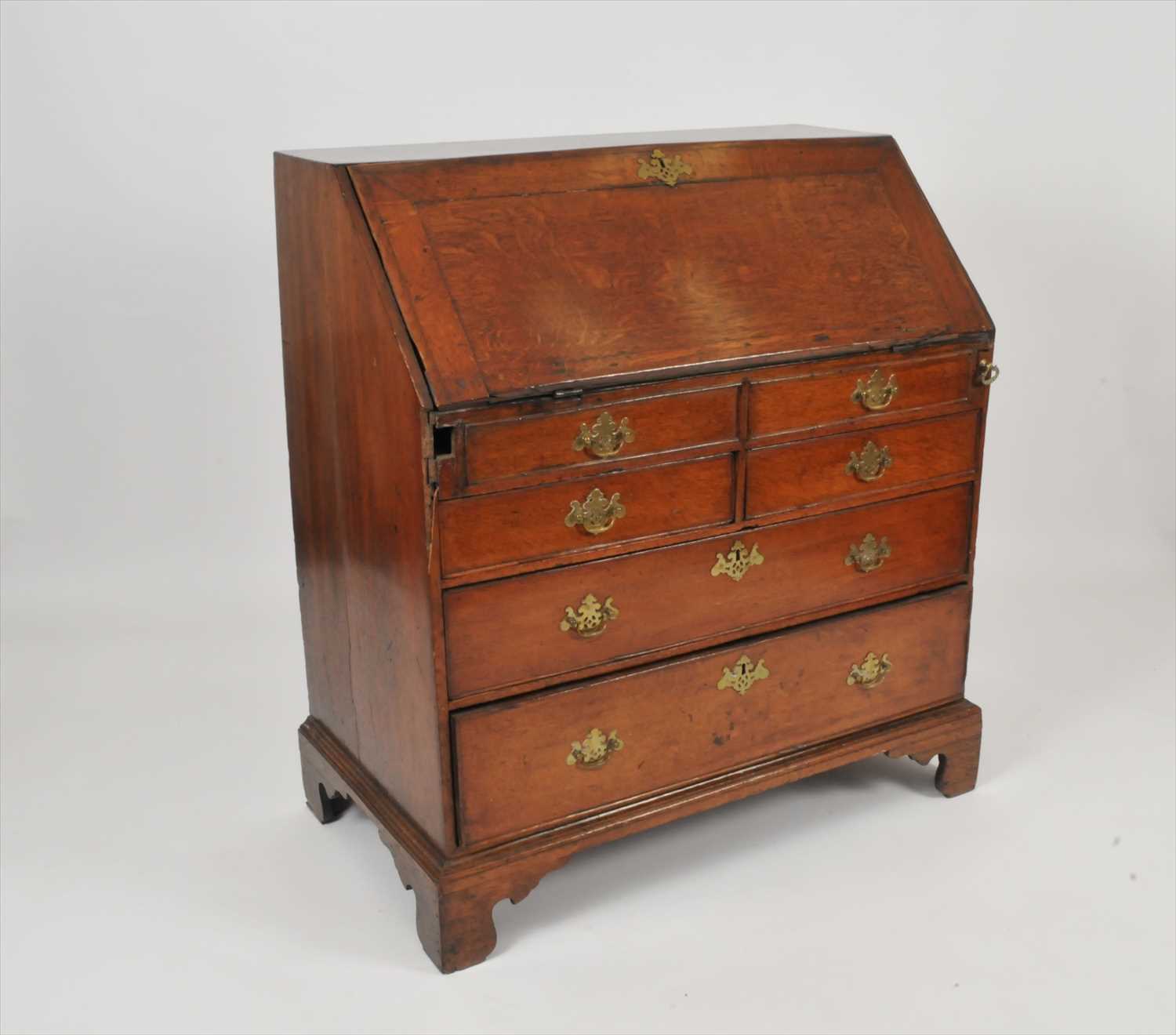 A rustic 19th century oak bureau, with an internal alignment over two ...
