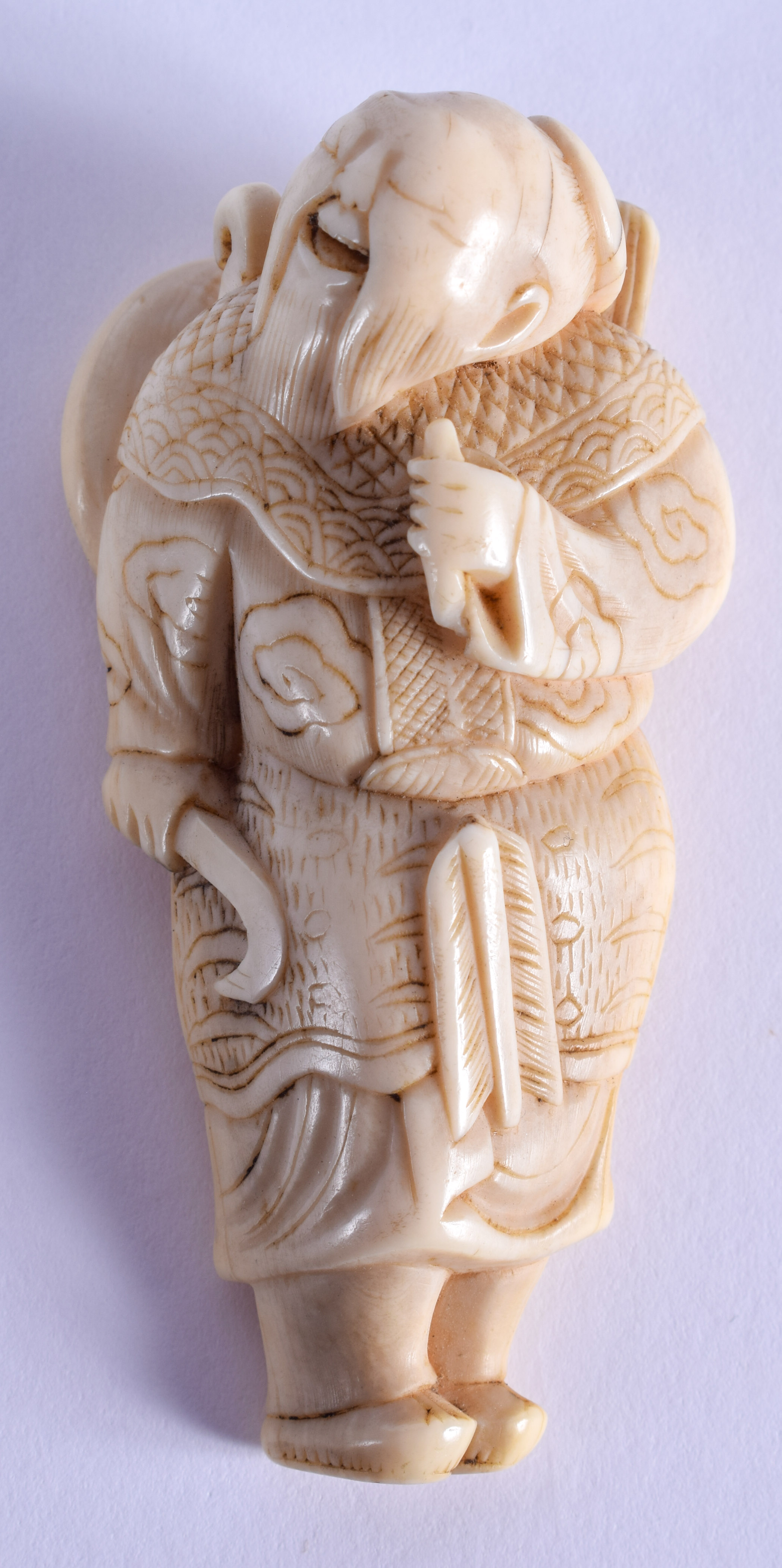 AN 18TH CENTURY JAPANESE EDO PERIOD CARVED IVORY NETSUKE modelled as a ...