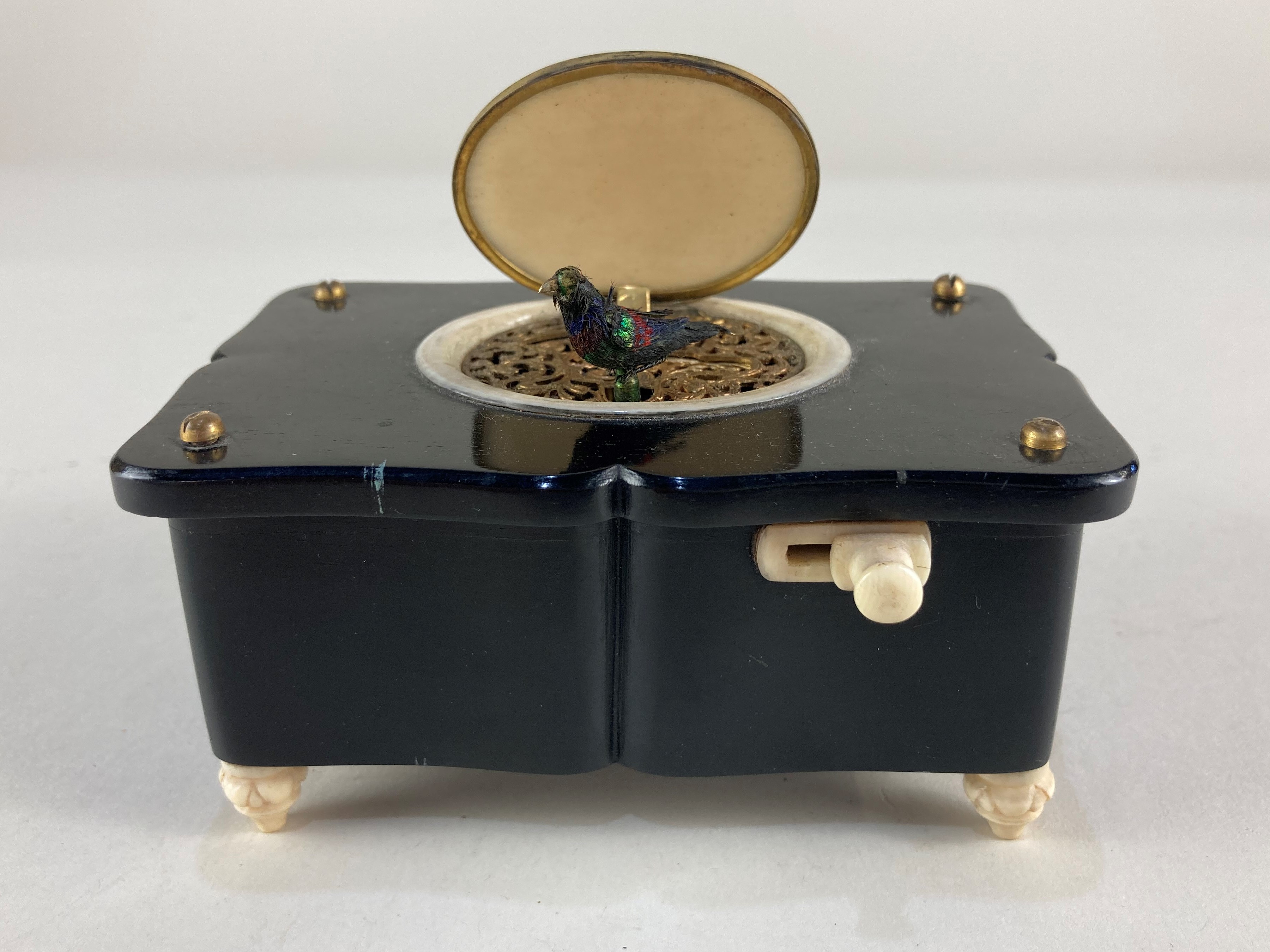 A 19th century singing bird automaton music box, the gilt and ivory lid ...