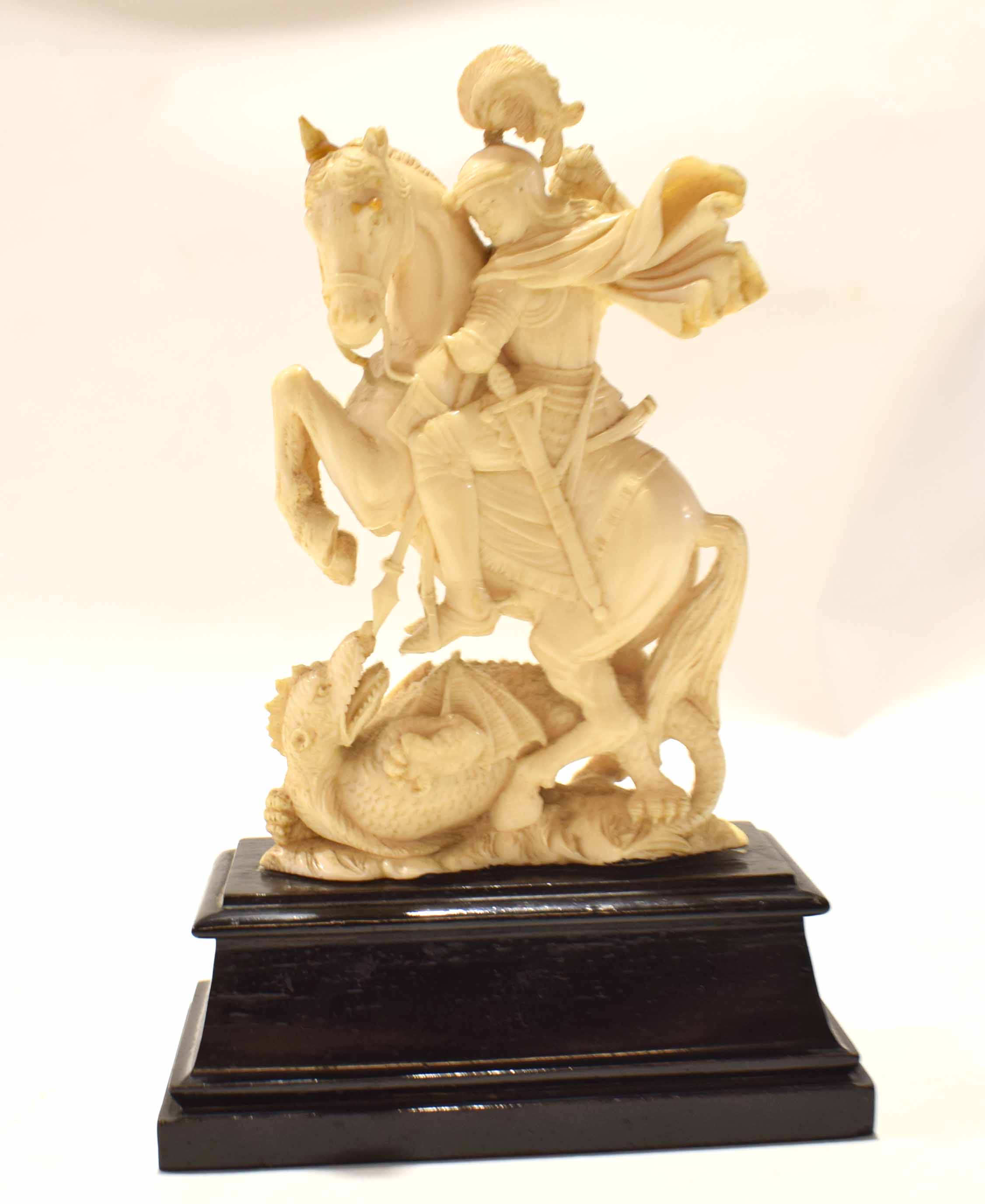 Late 19th century ivory carving of St George and the Dragon on a wooden ...