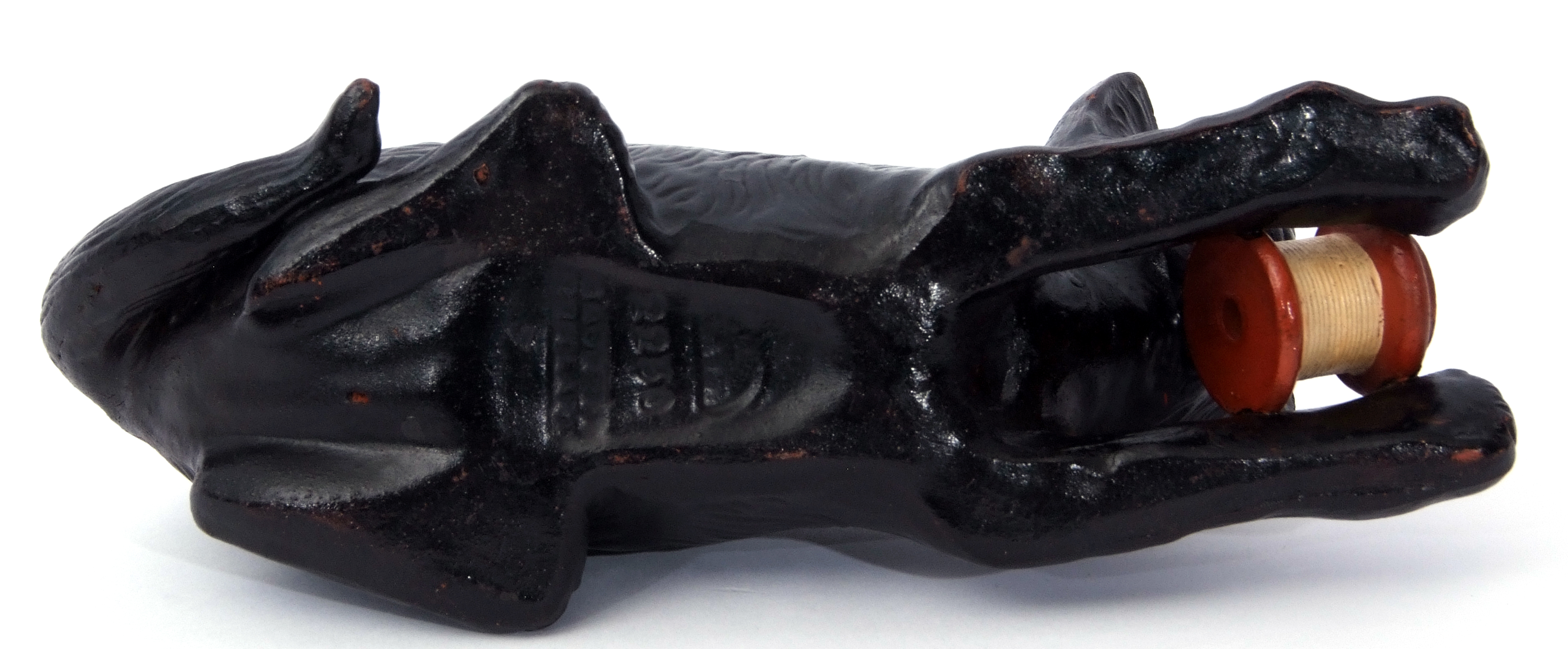 Unusual Bretby pottery model of a cat with glass eyes holding a reel of ...