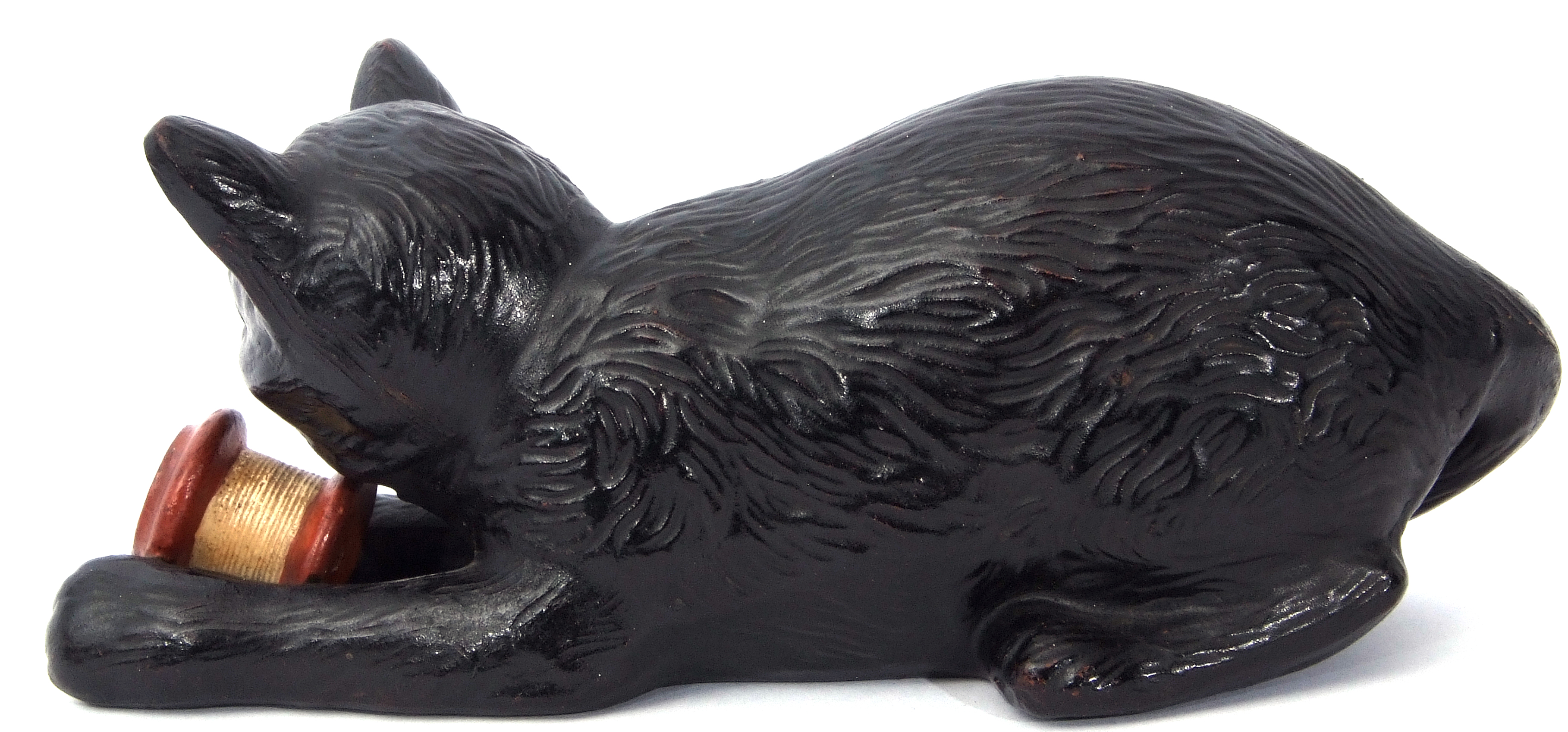Unusual Bretby pottery model of a cat with glass eyes holding a reel of ...