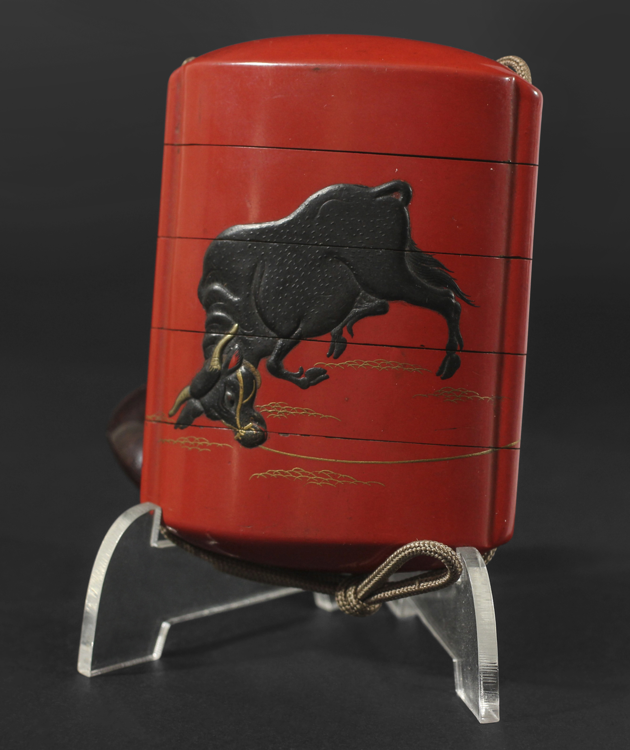 JAPANESE RED LACQUER FIVE SECTION INRO, decorated in relief in black ...
