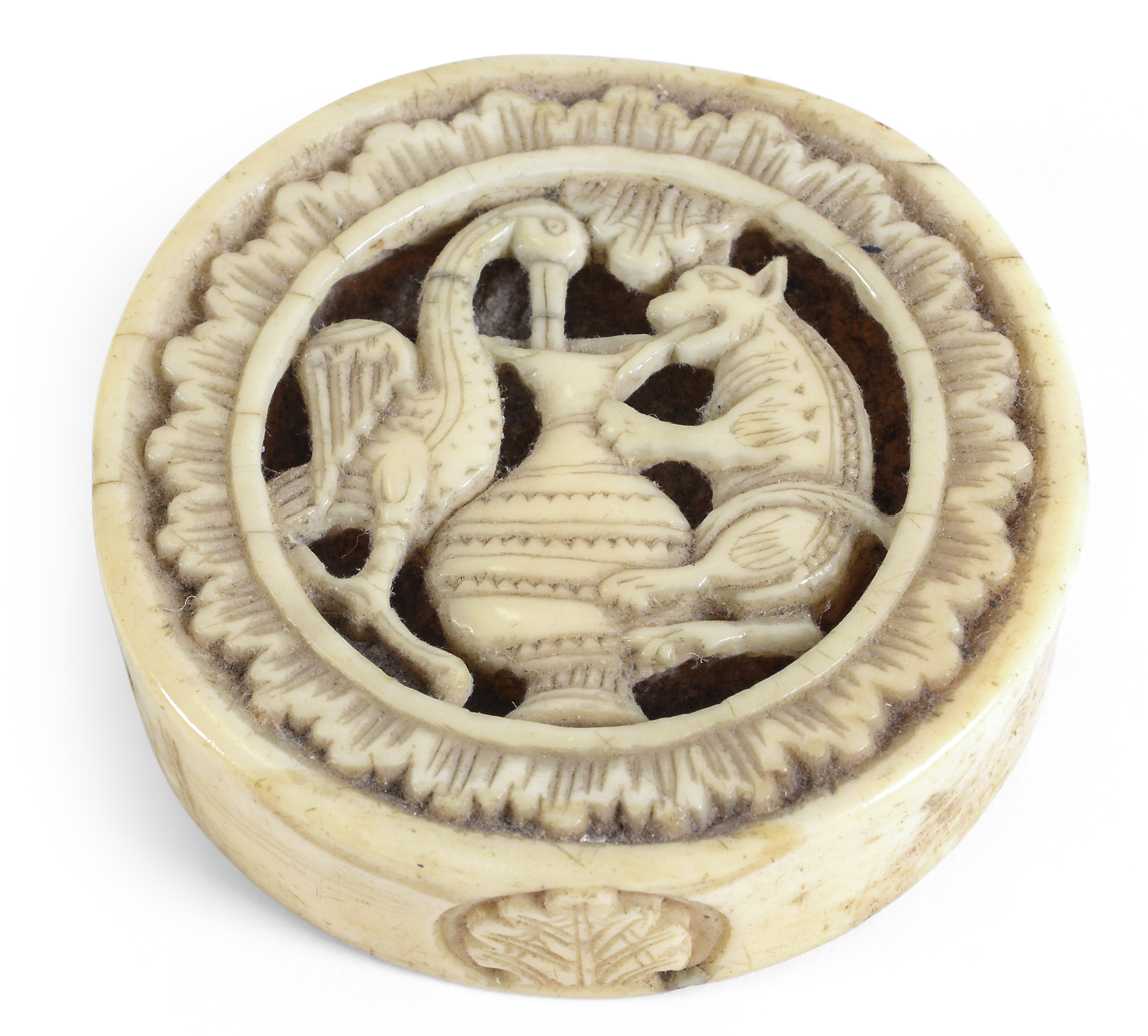 A MEDIEVAL WALRUS IVORY DRAUGHTSMAN carved to illustrate Aesop's fable ...