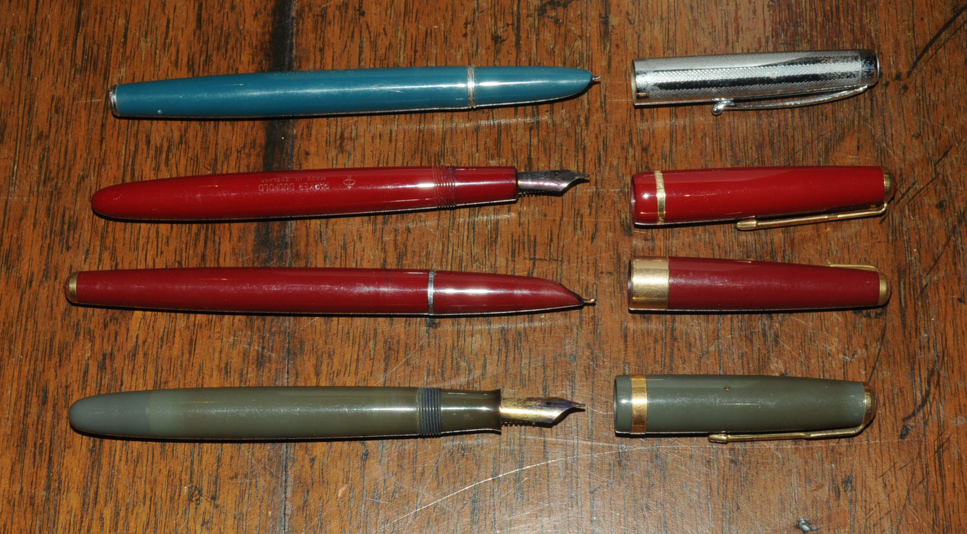 A collection of vintage fountain pens, including Burnham propelling ...