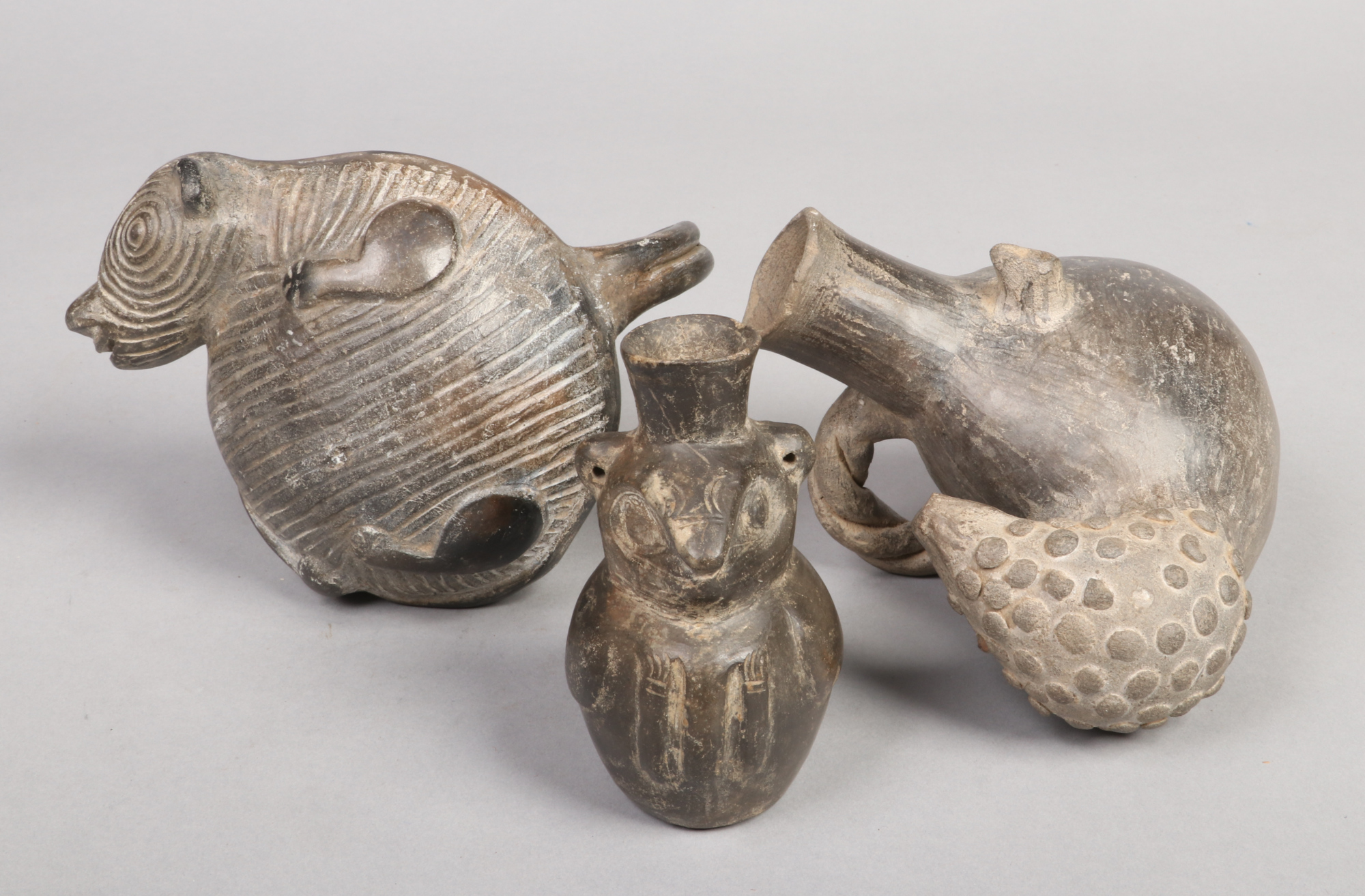 Three Peruvian black pottery zoomorphic flasks. Largest 15cm. Smallest ...