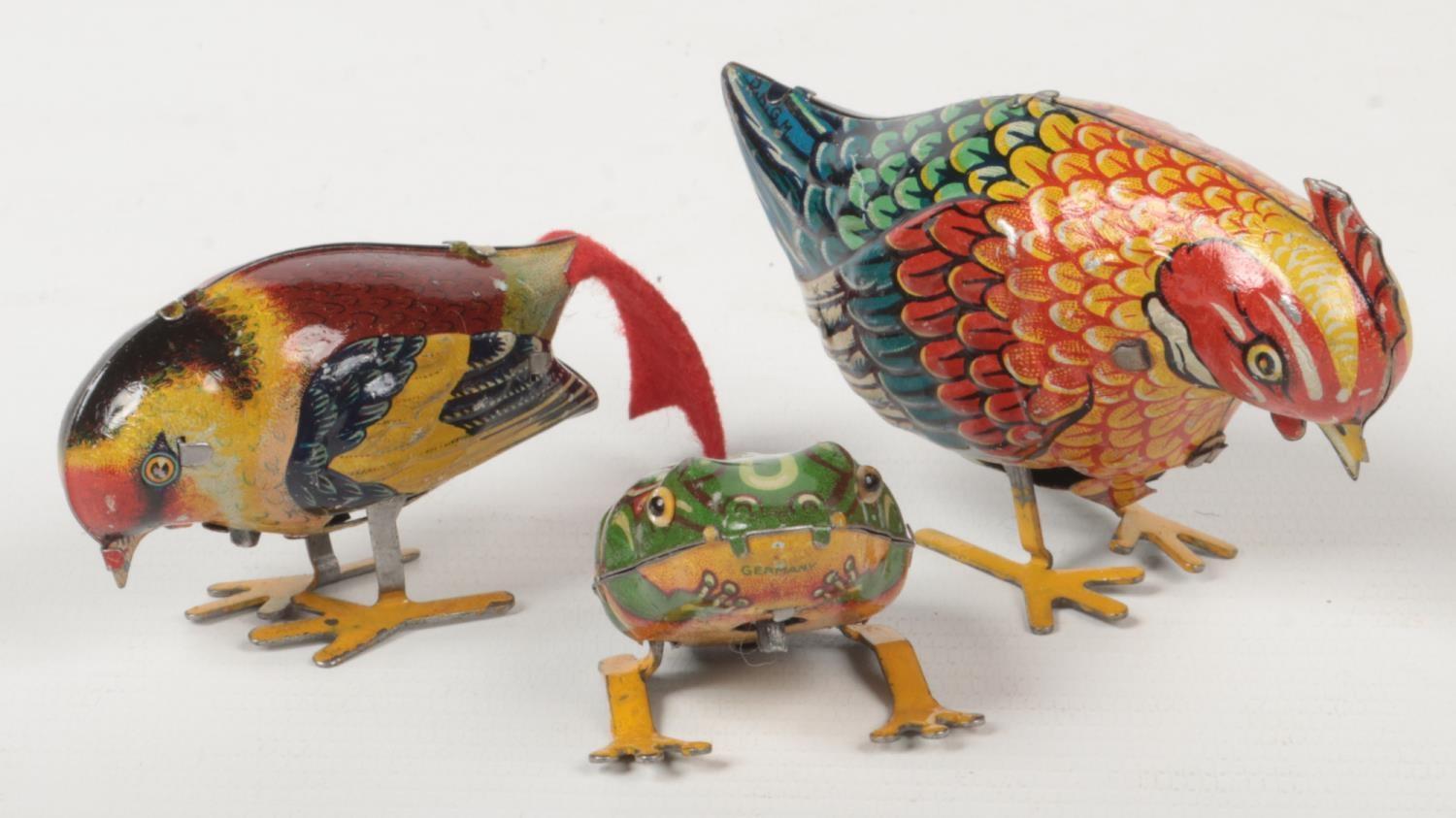 Three German tinplate clockwork toys. Two birds and a frog, largest 9.25cm.