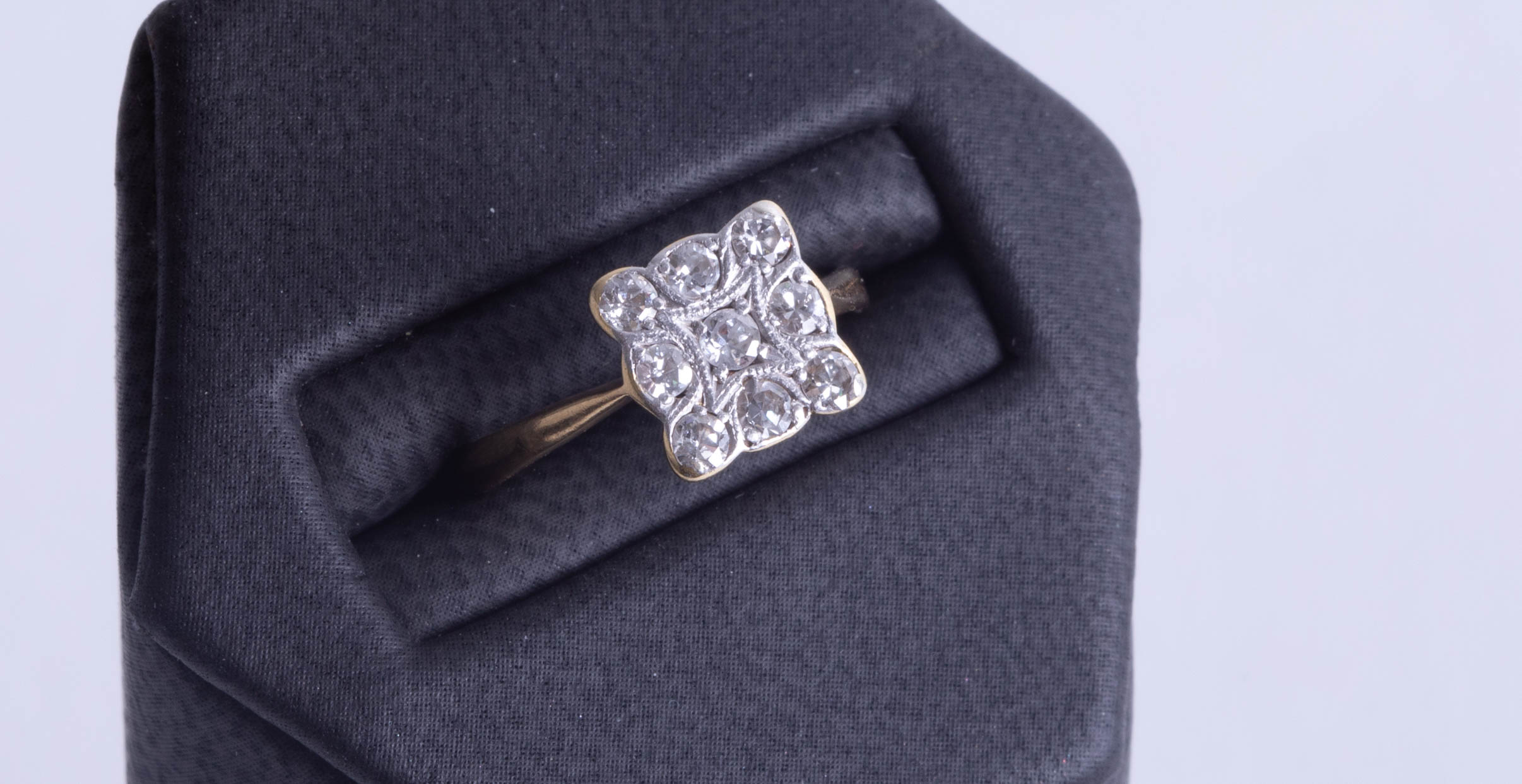An 18ct antique nine stone diamond ring of square design, size L.