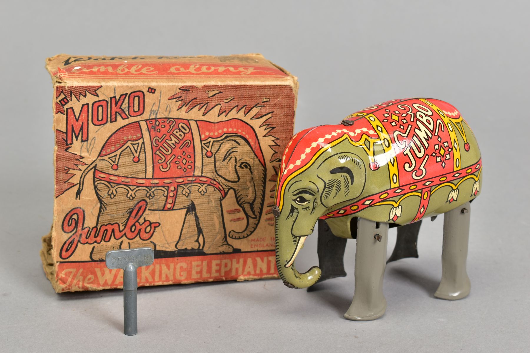 A BOXED MOKO TINPLATE CLOCKWORK JUMBO THE WALKING ELEPHANT, grey with ...