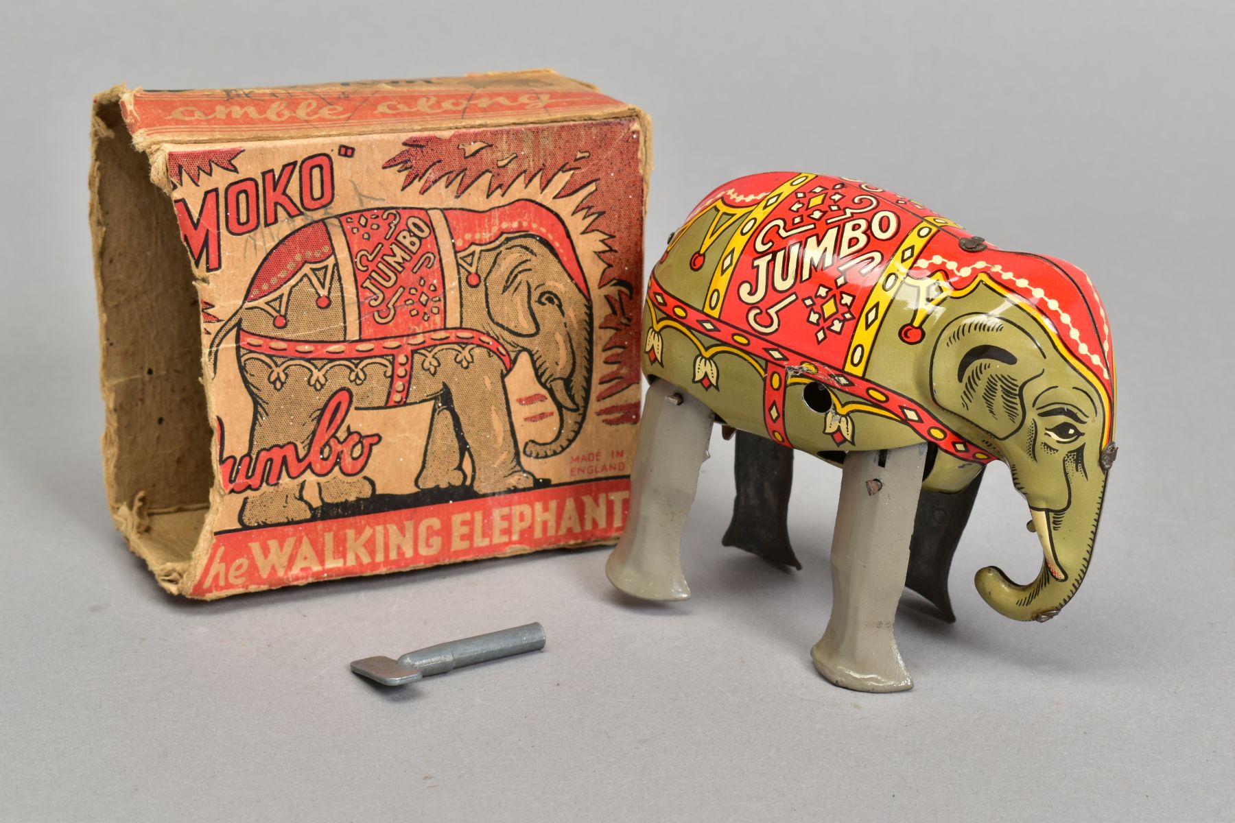 A BOXED MOKO TINPLATE CLOCKWORK JUMBO THE WALKING ELEPHANT, grey with ...