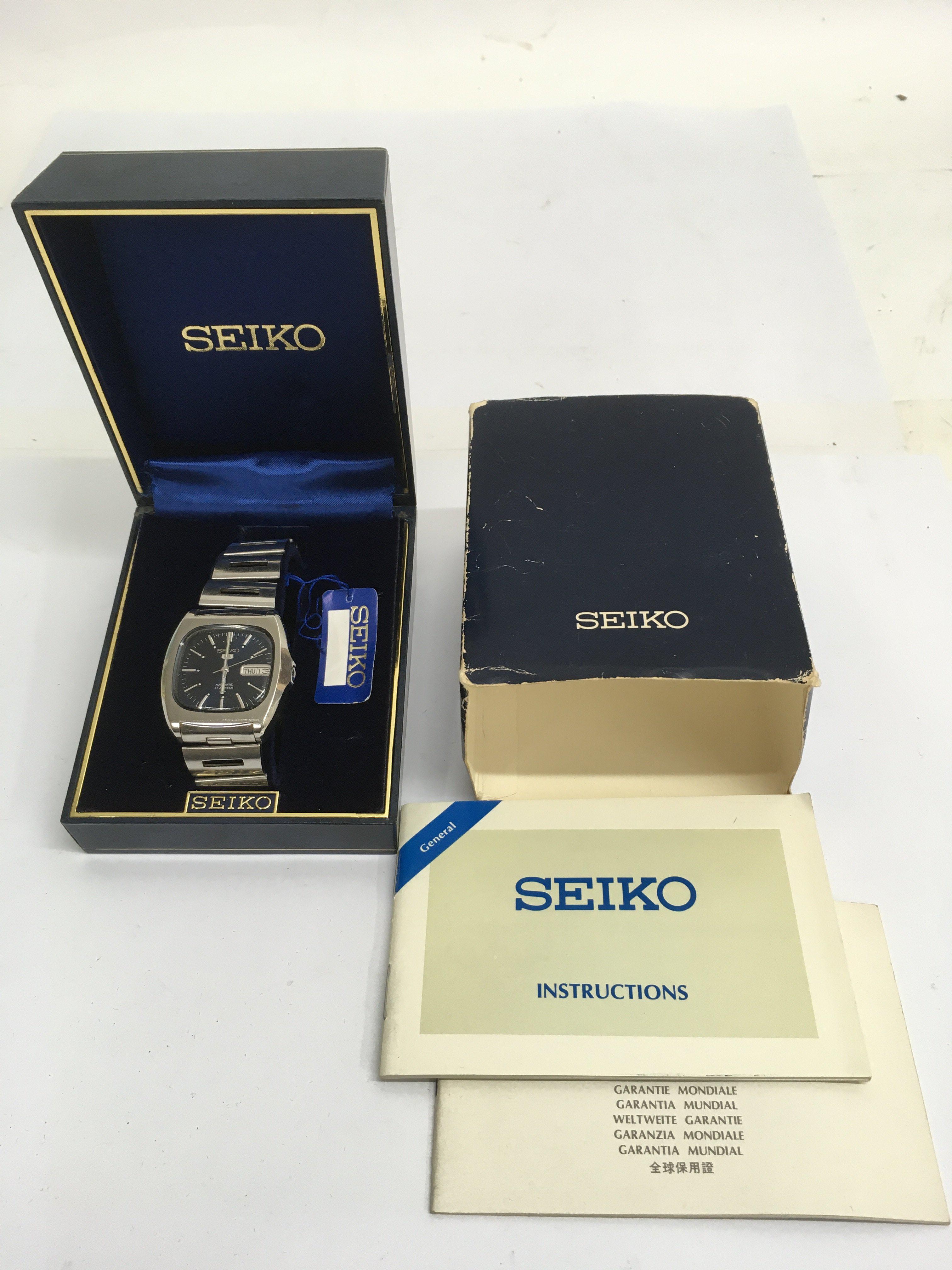 A gent's, vintage square face stainless steel Seiko watch with box and book