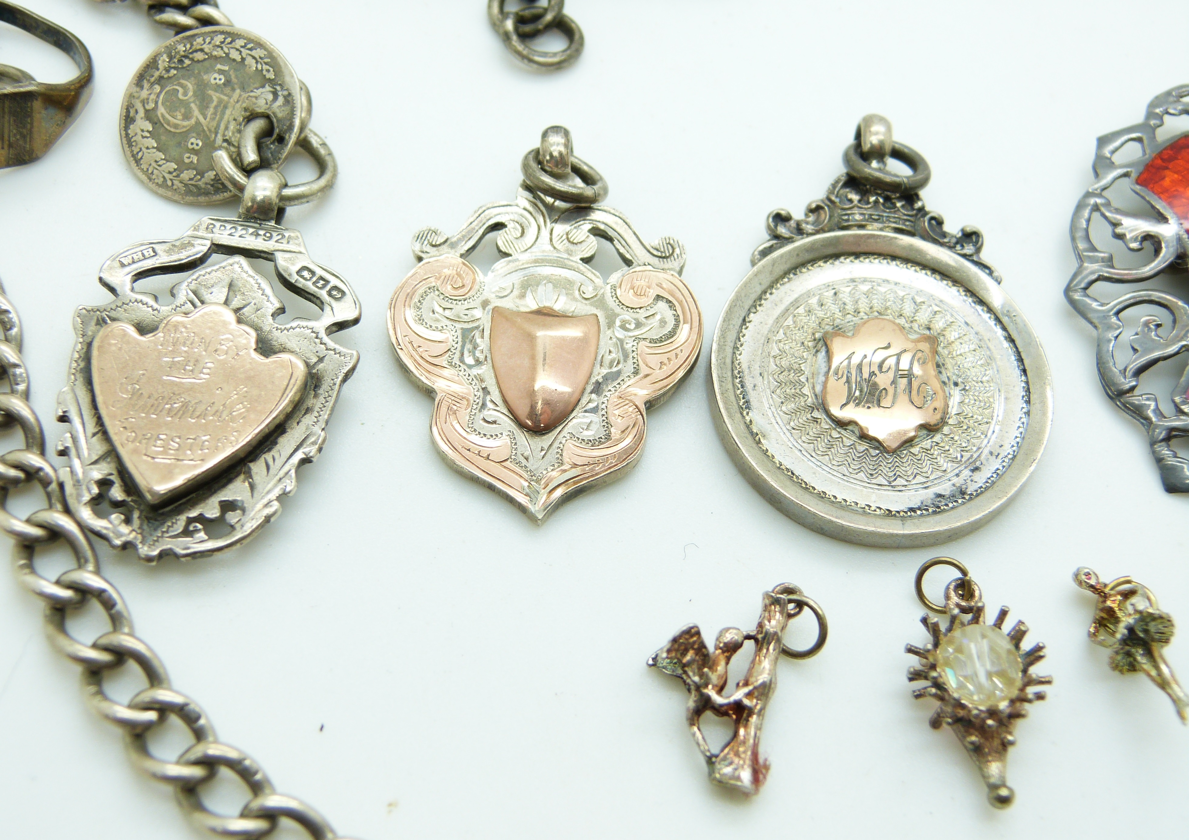 A hallmarked silver albert/ fob, three hallmarked silver fobs with ...