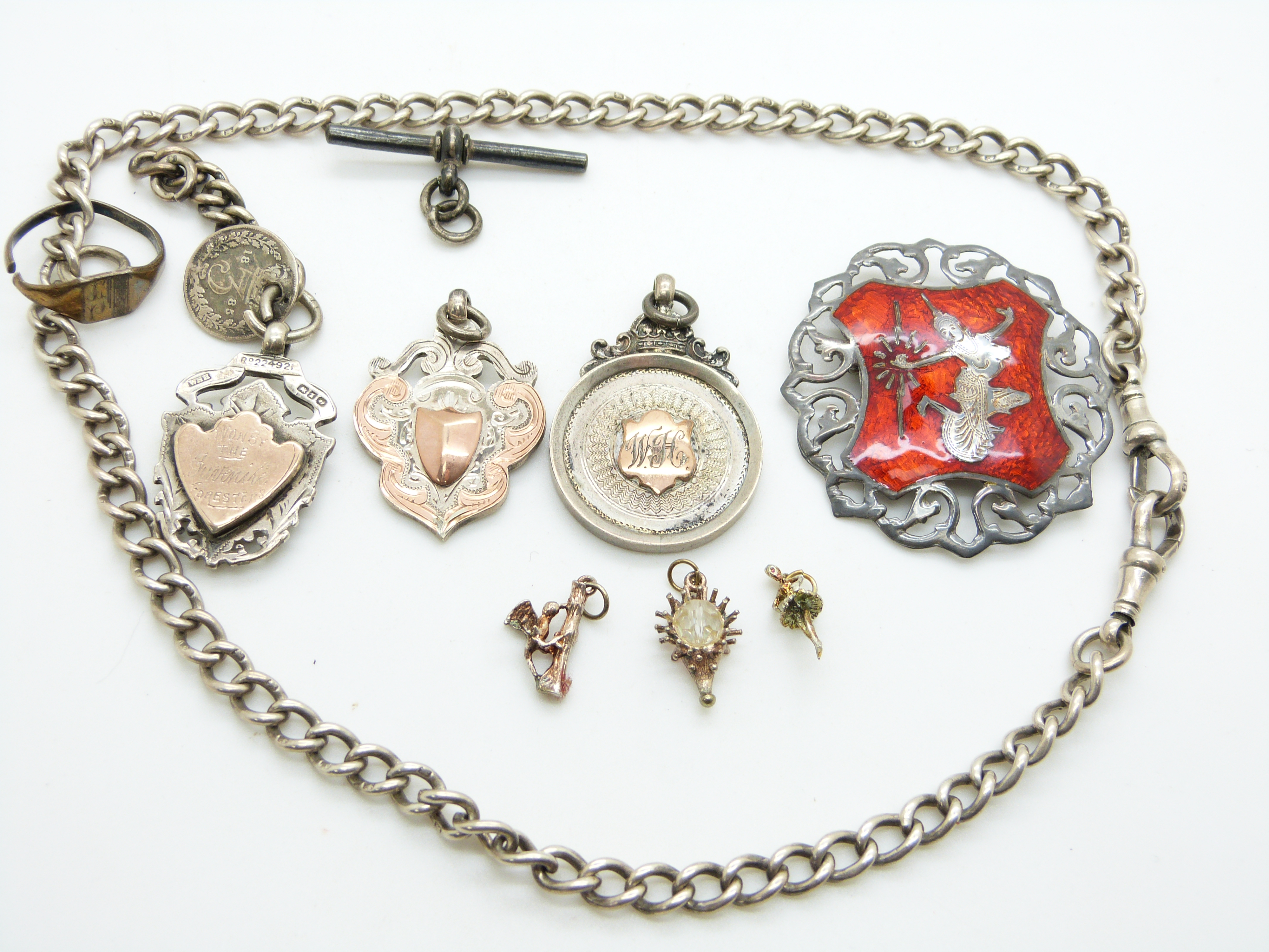 A hallmarked silver albert/ fob, three hallmarked silver fobs with ...