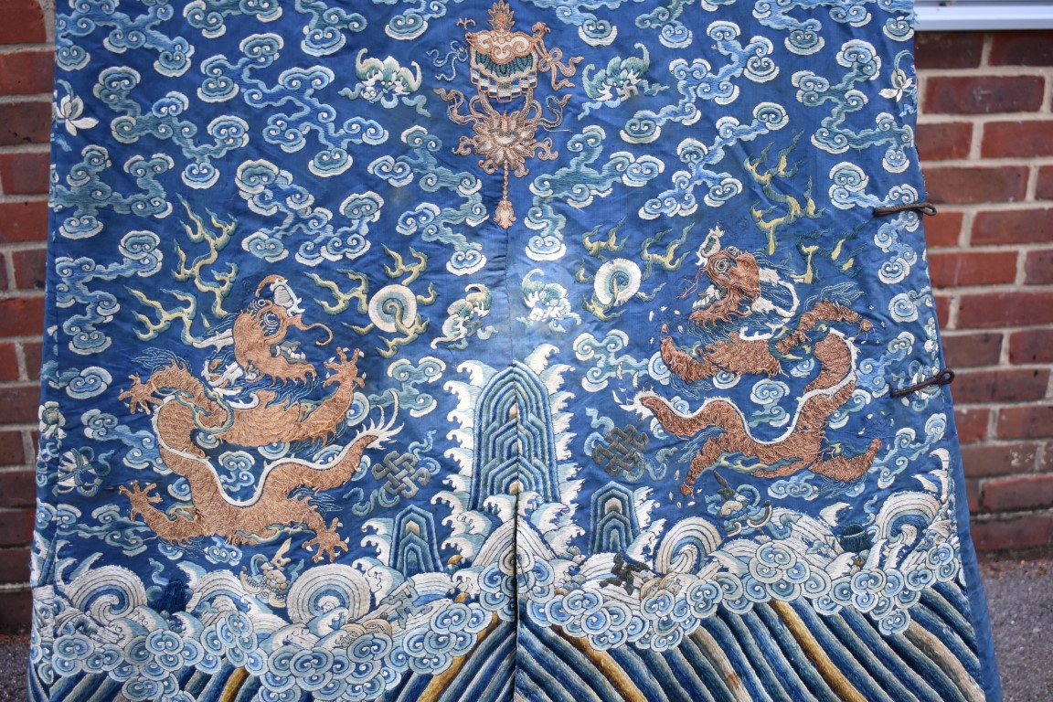 A Chinese silk embroidered nine-dragon robe, 19th century, decorated ...
