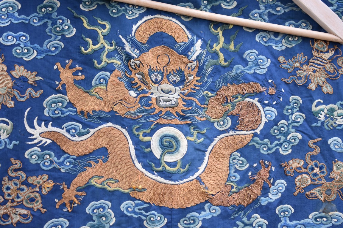 A Chinese silk embroidered nine-dragon robe, 19th century, decorated ...