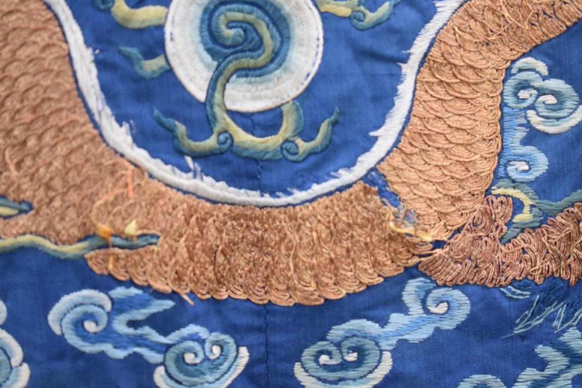 A Chinese silk embroidered nine-dragon robe, 19th century, decorated ...