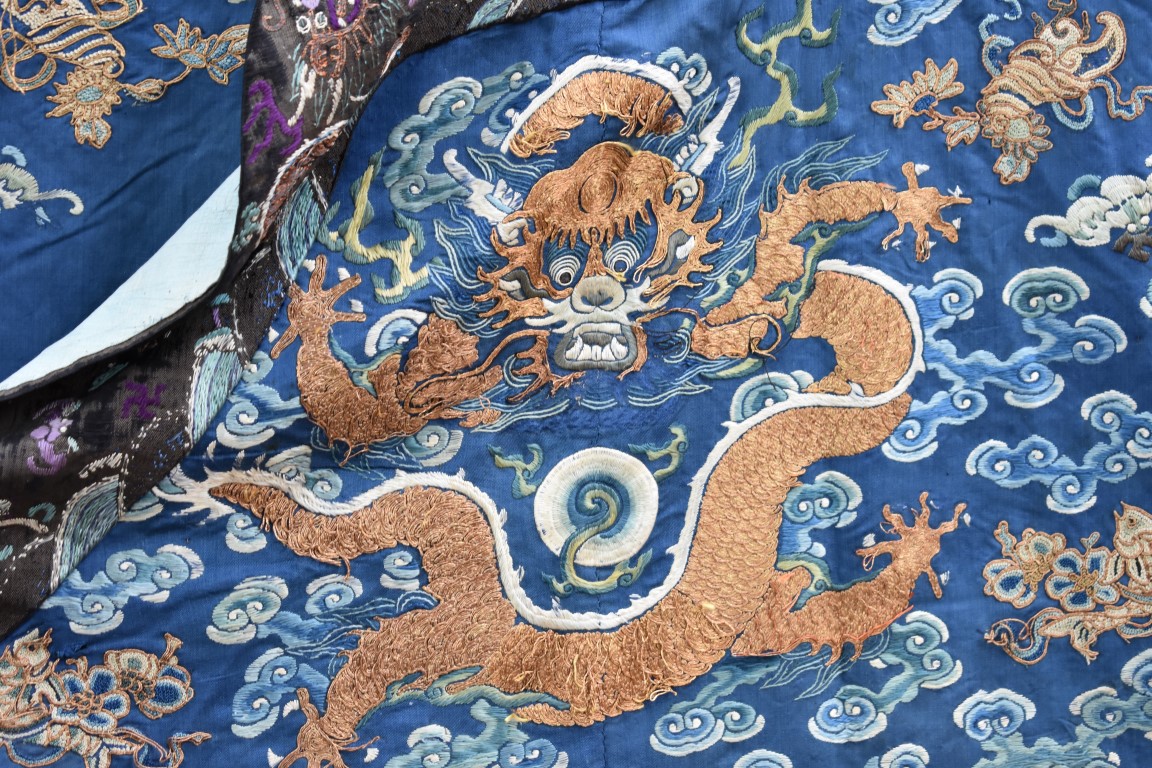 A Chinese silk embroidered nine-dragon robe, 19th century, decorated ...