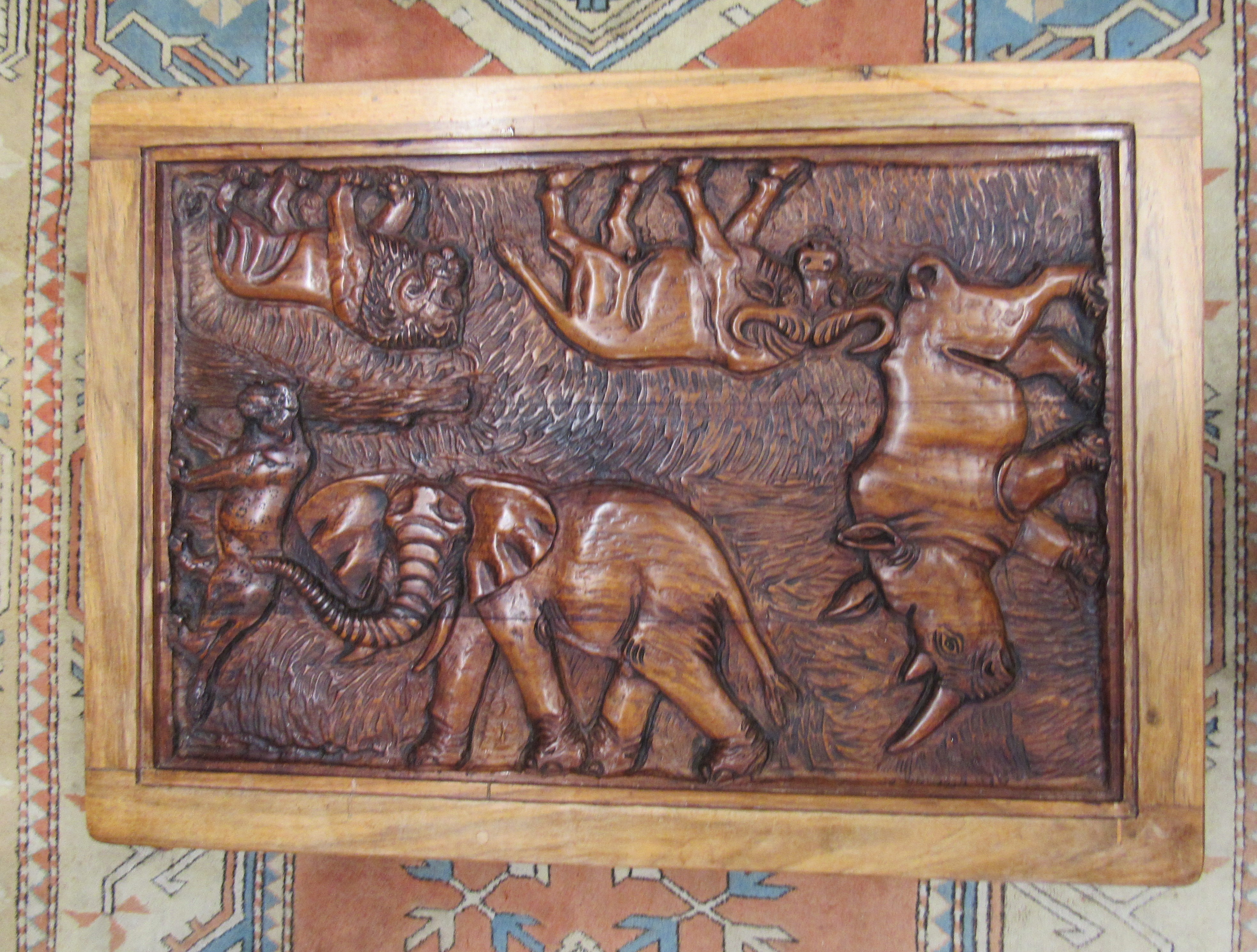 A glass topped African wood coffee table from Zimbabwe, the top with ...