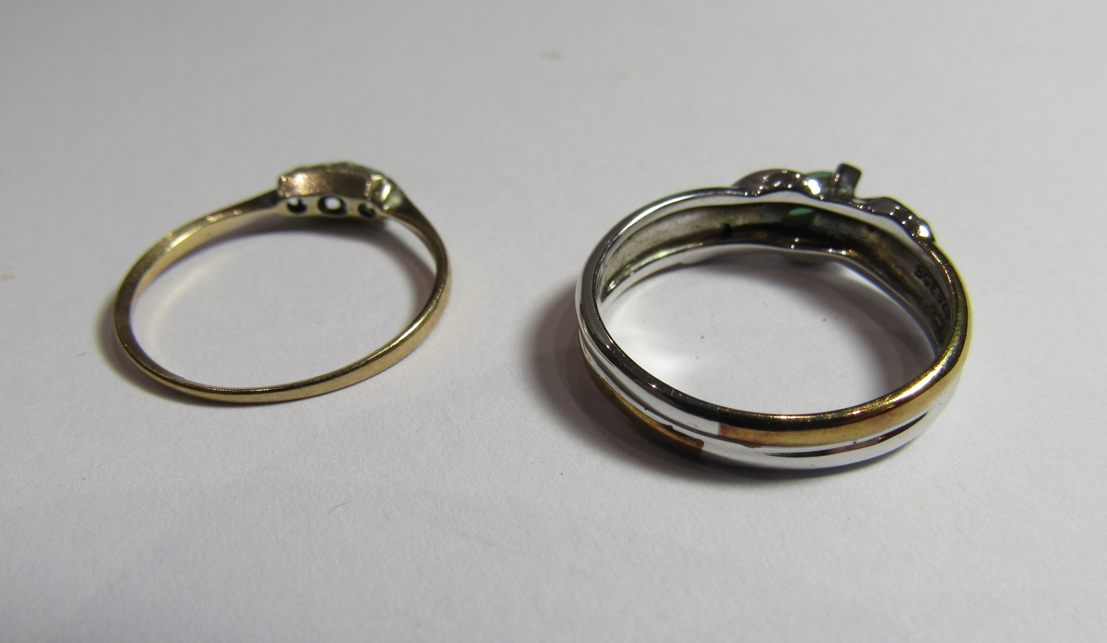 A gold, platinum and diamond accent dress ring, with faded markings ...