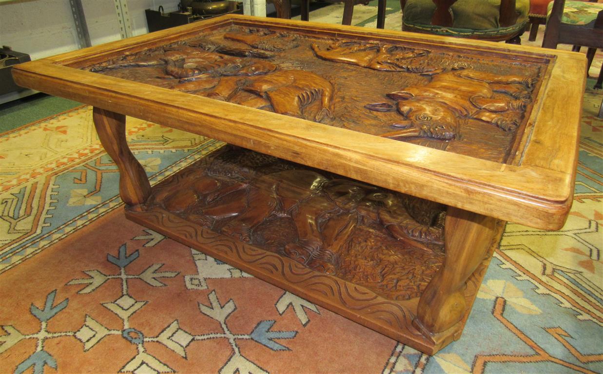 A glass topped African wood coffee table from Zimbabwe, the top with ...