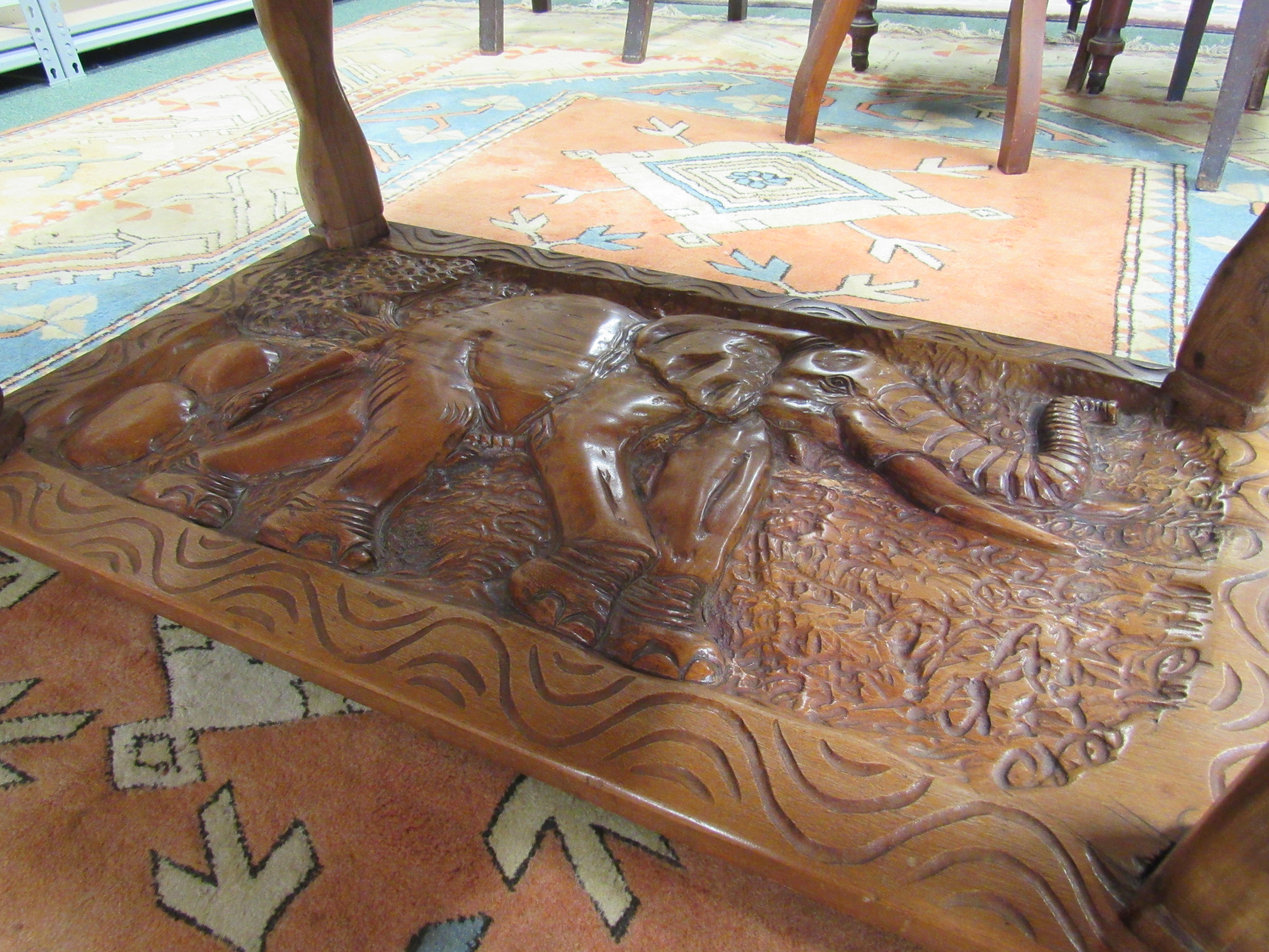A glass topped African wood coffee table from Zimbabwe, the top with ...