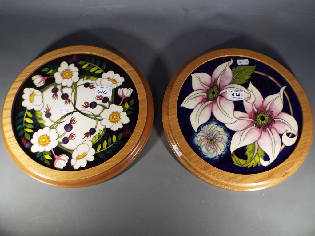 Moorcroft - two Moorcroft Pottery framed plaques decorated in the Pure ...