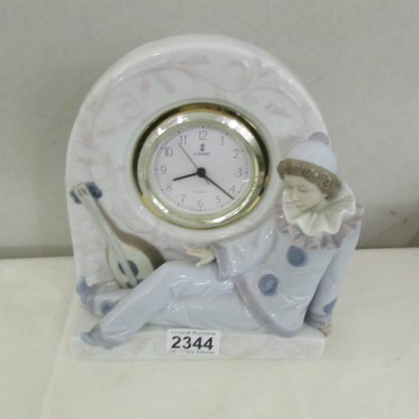 A Lladro mantel clock featuring a pierrot.