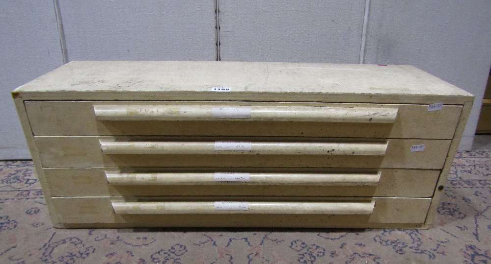 A vintage painted wooden nest of four long shallow drawers with ...