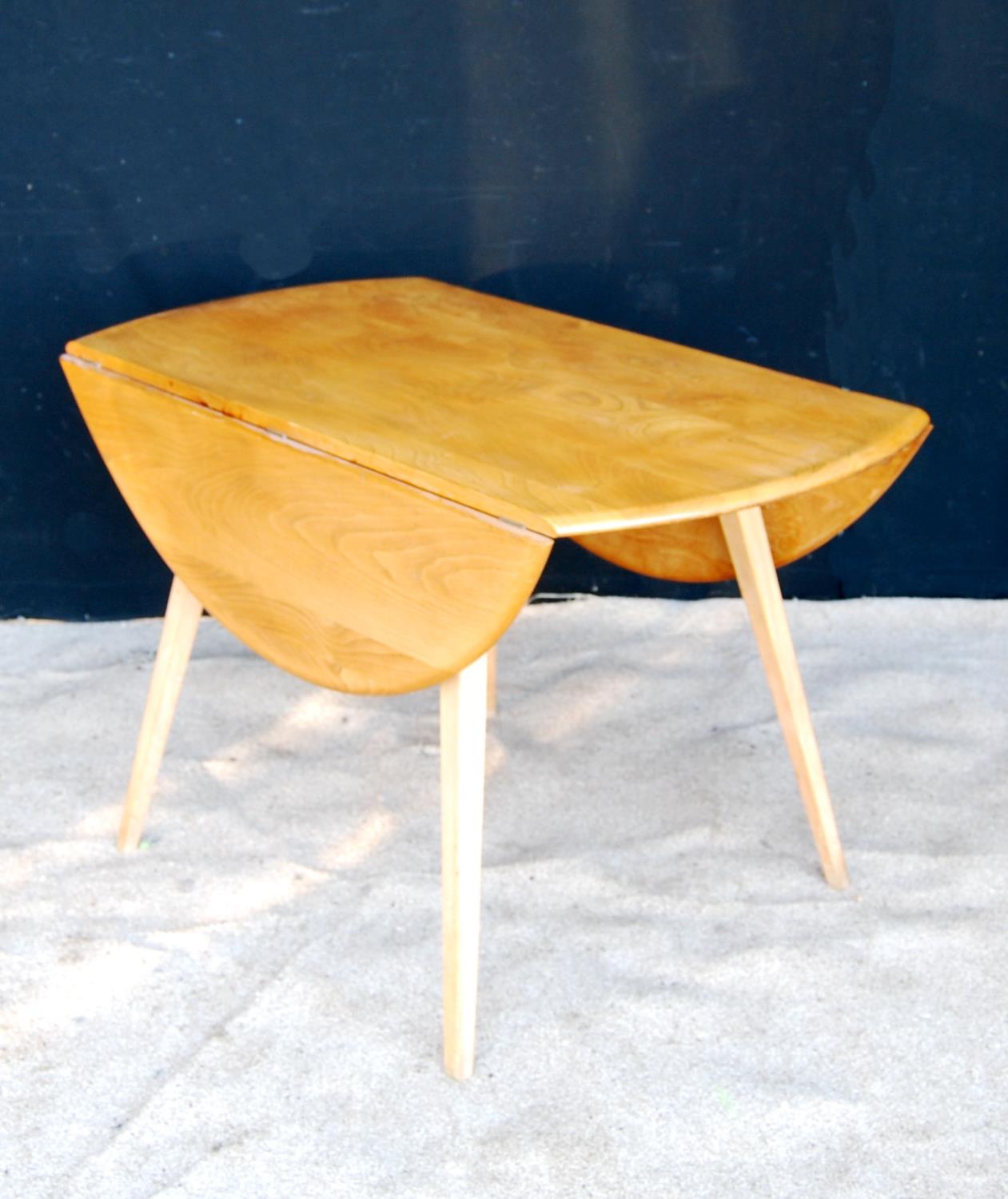 Ercol drop-flap table with oval top, raised on splayed tapering square ...