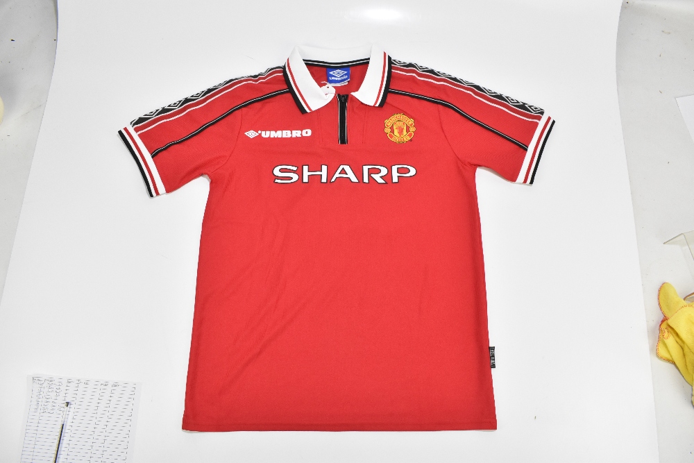 MANCHESTER UNITED FC; an Umbro home shirt with Sharp logo signed and ...