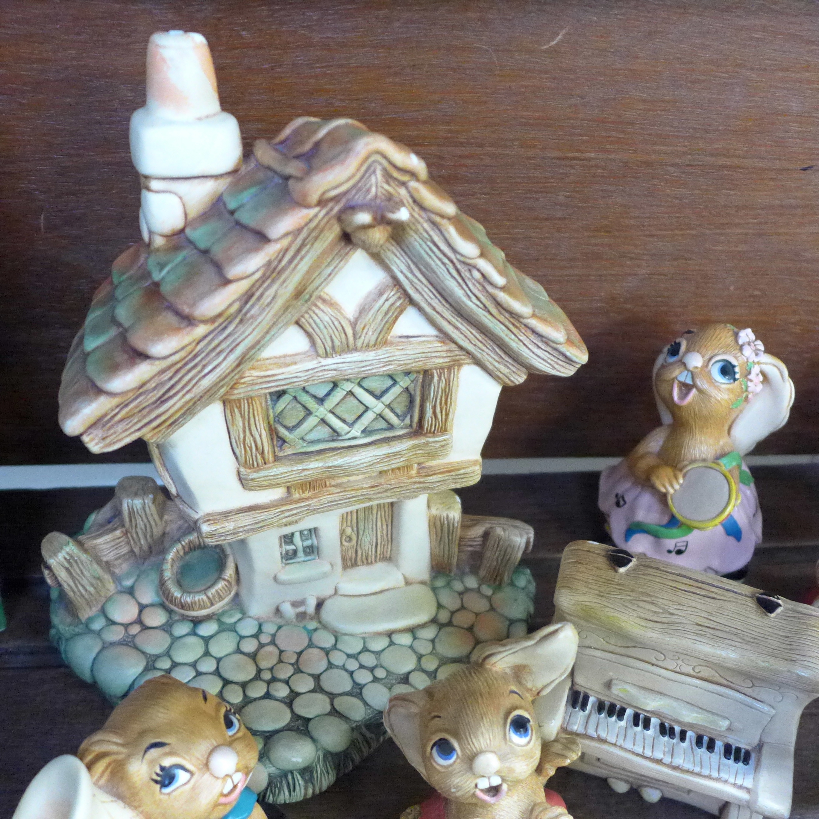 A collection of Pendelfin rabbits and house