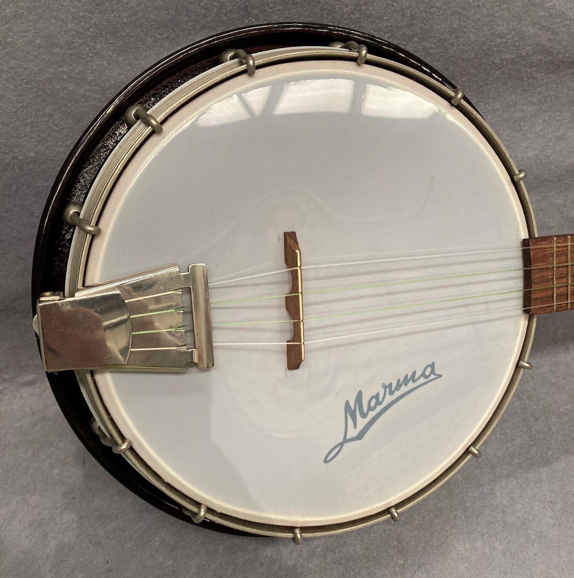 A Marina four string banjo 64cm long