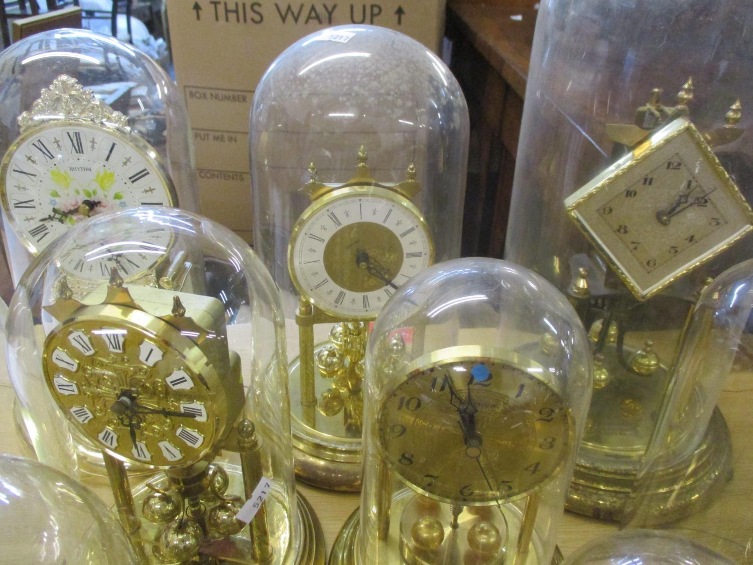 Eight anniversary clocks with glass and plastic domes, together with ...