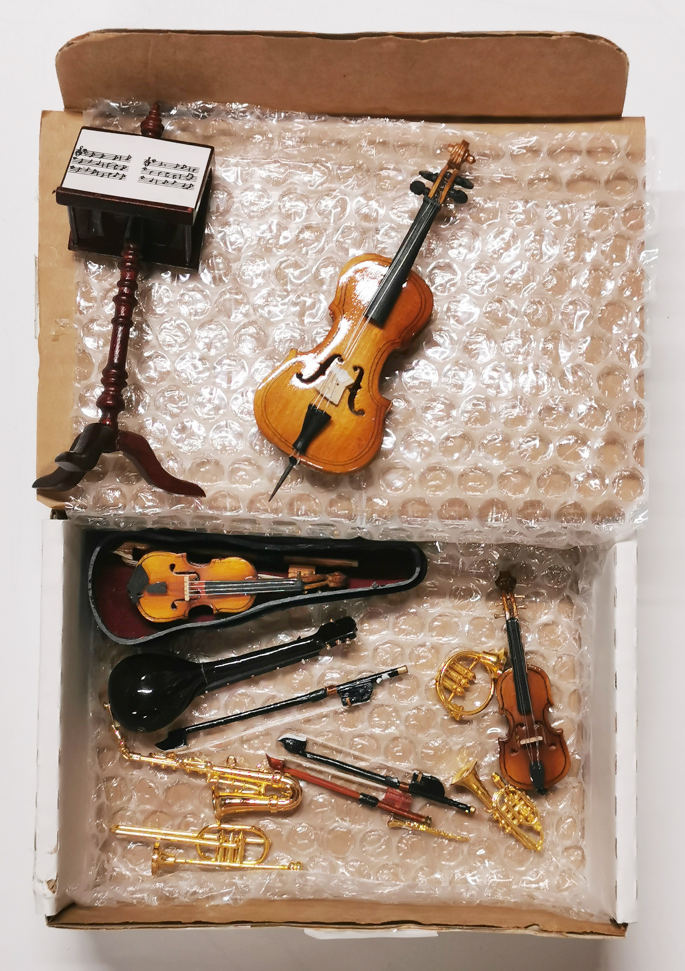 A quantity of dolls house musical instruments.