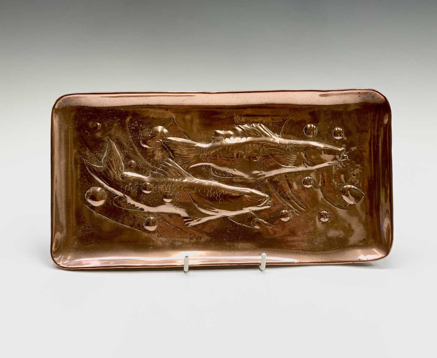 A Newlyn copper small rectangular tray, repousse decorated with fish ...