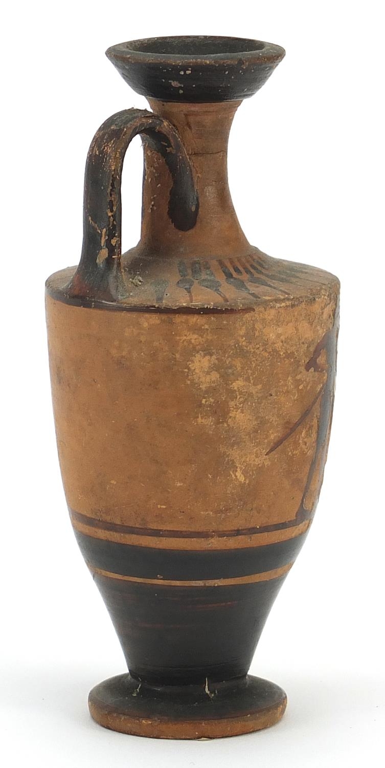 Attic pottery lekythos hand painted with warriors fighting before an ...