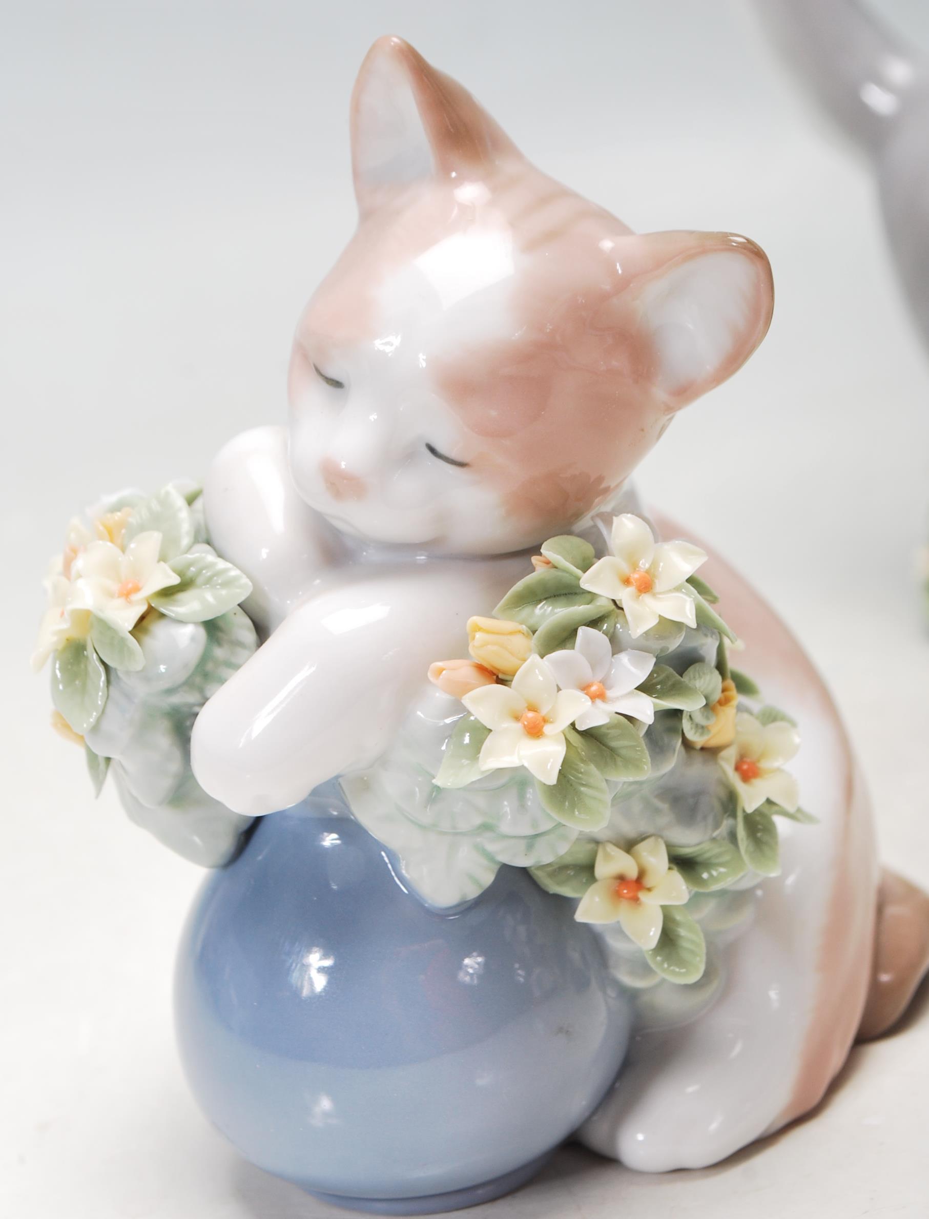 A collection of Lladro cat figurines, to include figures of kittens ...