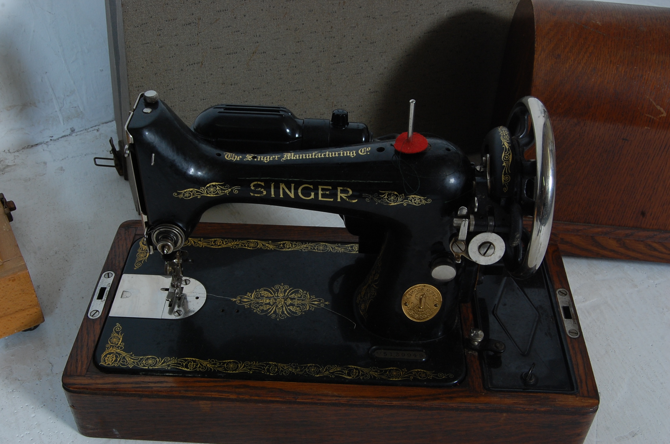 A collection of three vintage 20th century sewing machines comprising ...