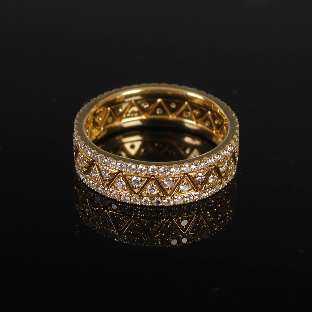 DOMINO JEWELLERY, An 18ct yellow gold and diamond ring formed as two ...