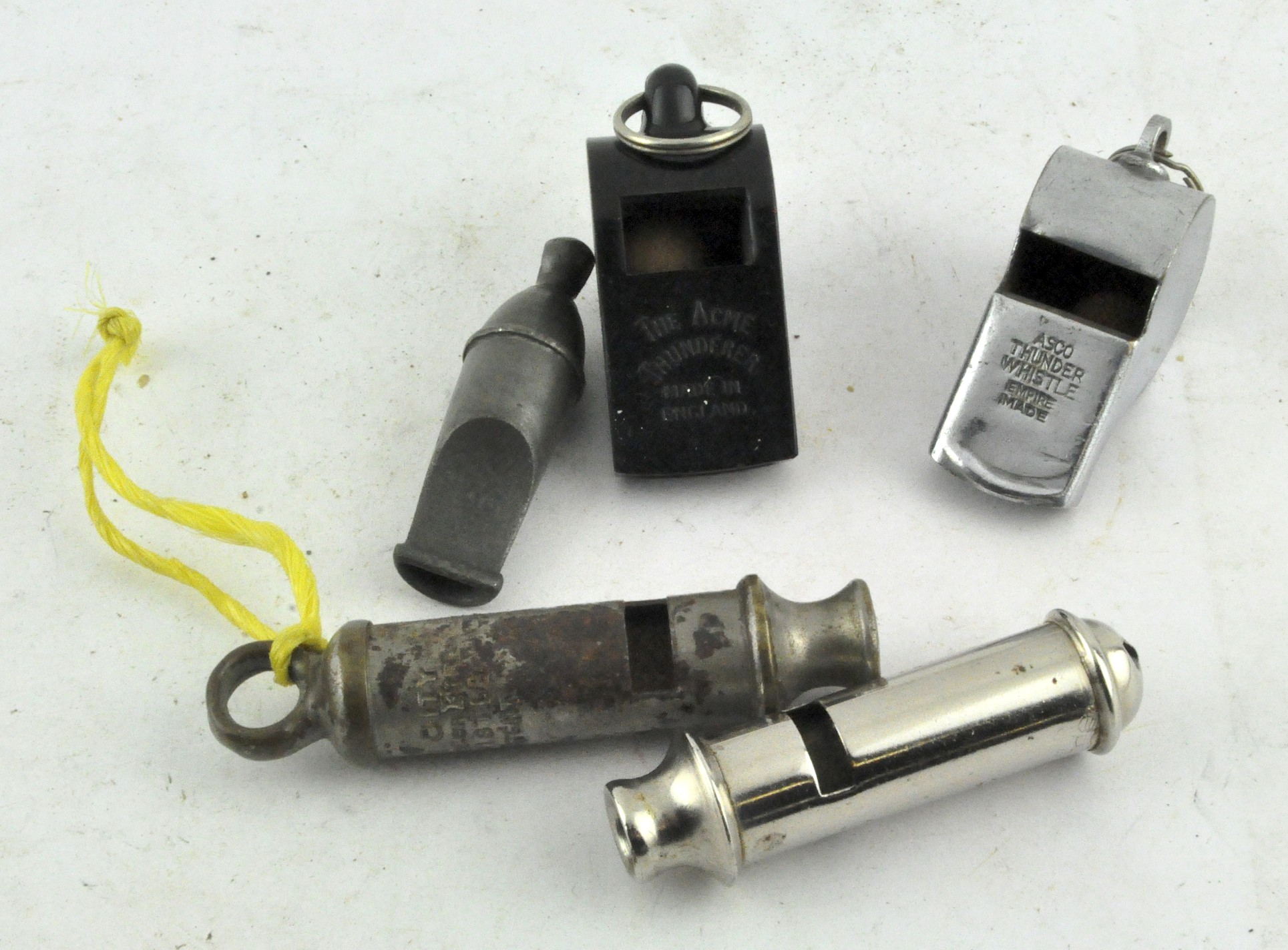 A group of five whistles, including a hawking whistle
