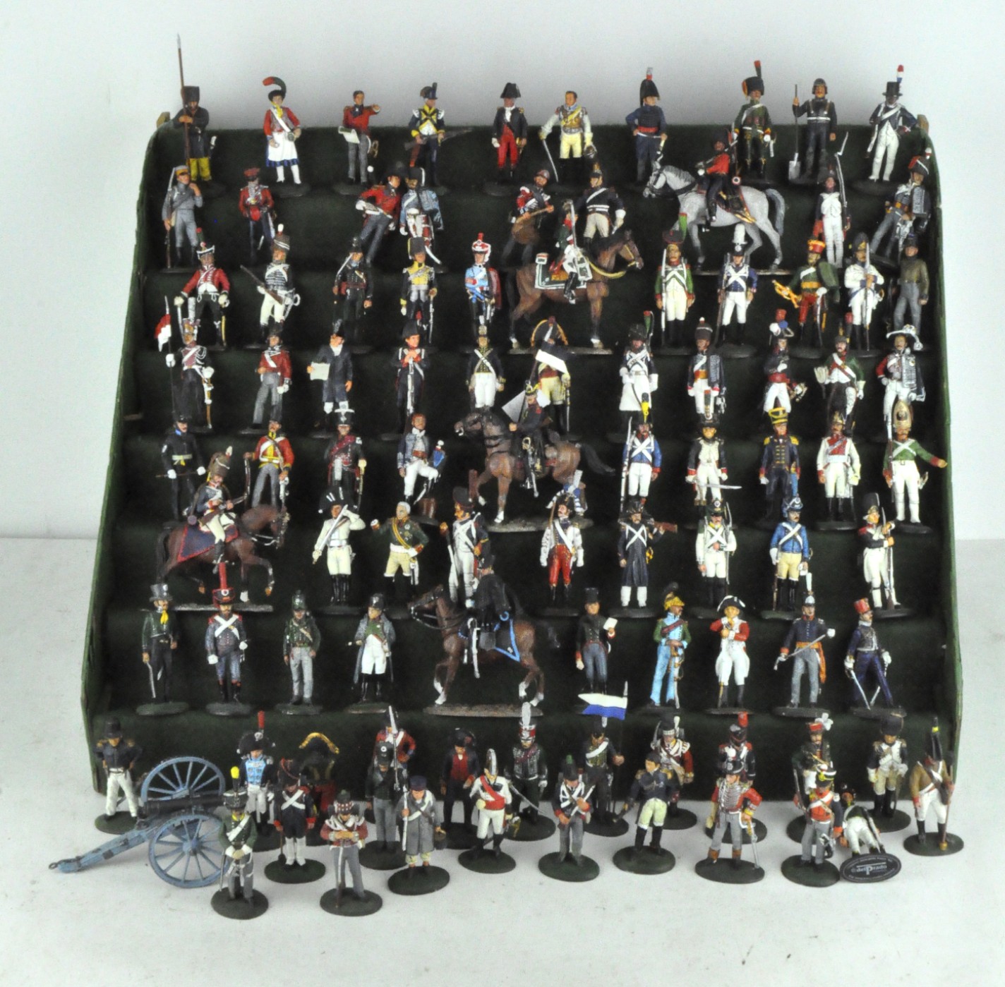 An extensive collection of Del Prado figures, on stand, including ...
