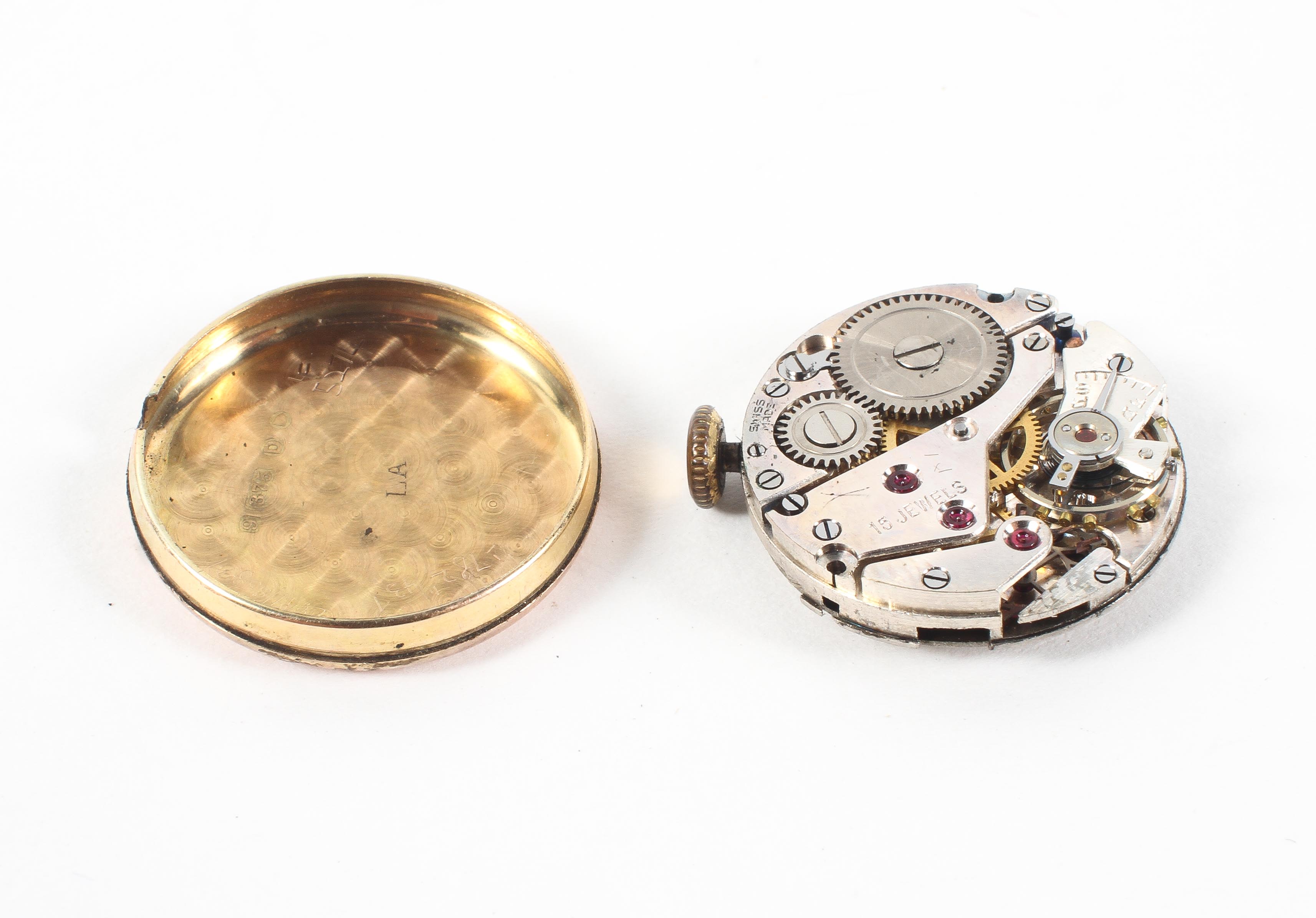 A yellow gold wristwatch. Circular dial with numerical markings ...