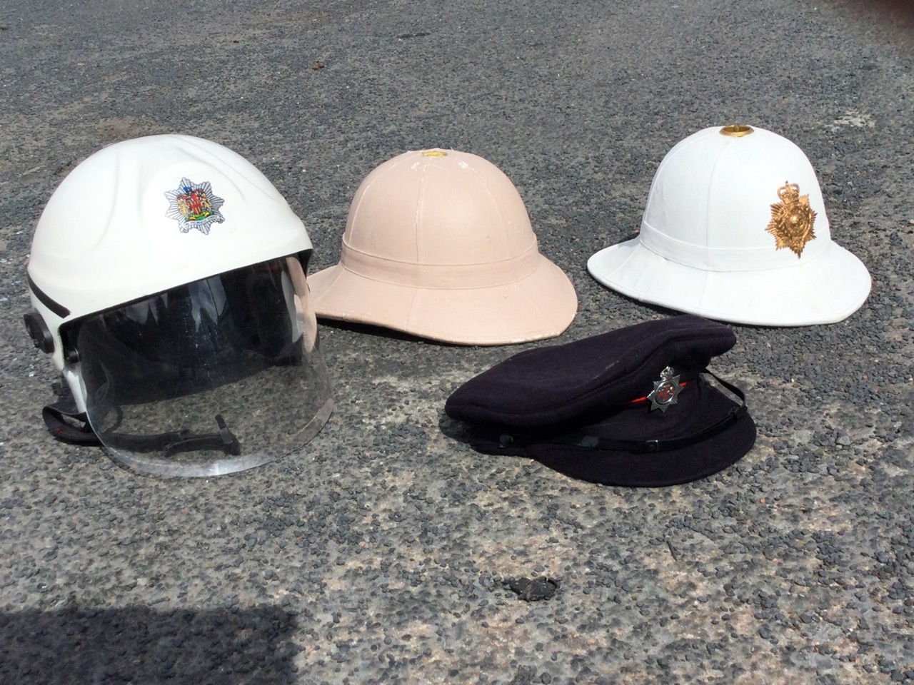 Two Royal Marines parade helmets; a modern firemans helmet with pull ...
