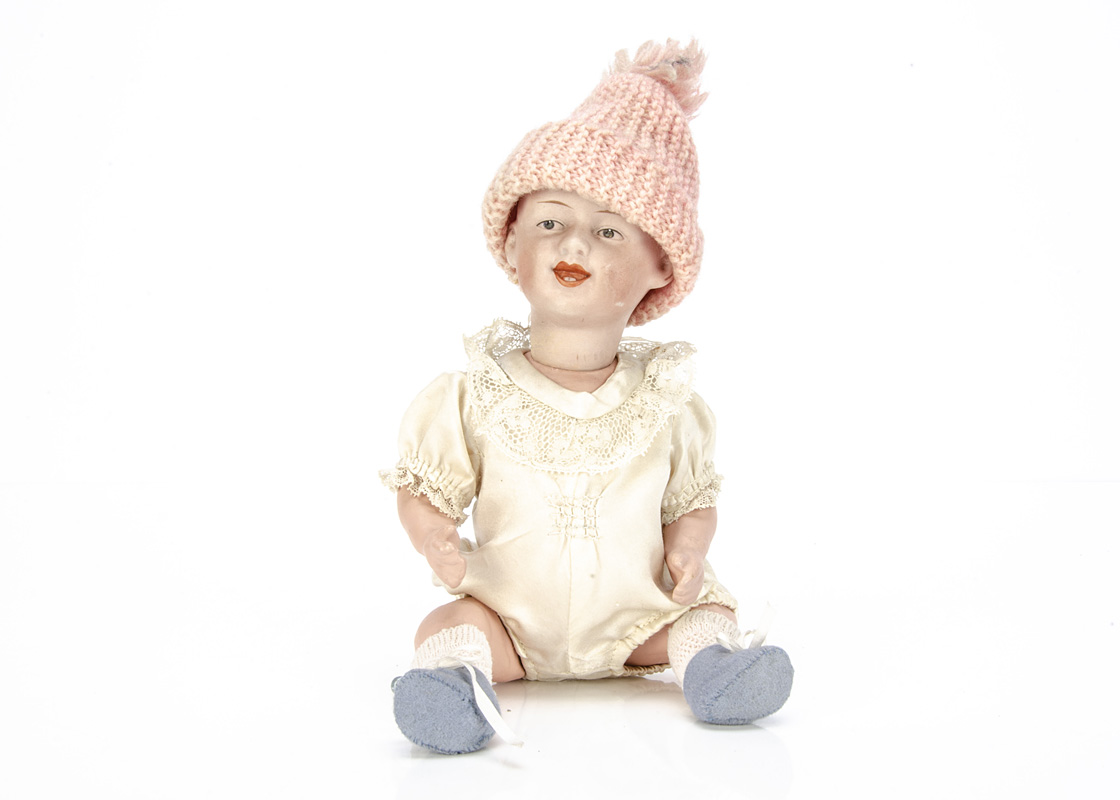 A Gebrüder Heubach 7604 laughing character baby, with blue intaglio ...