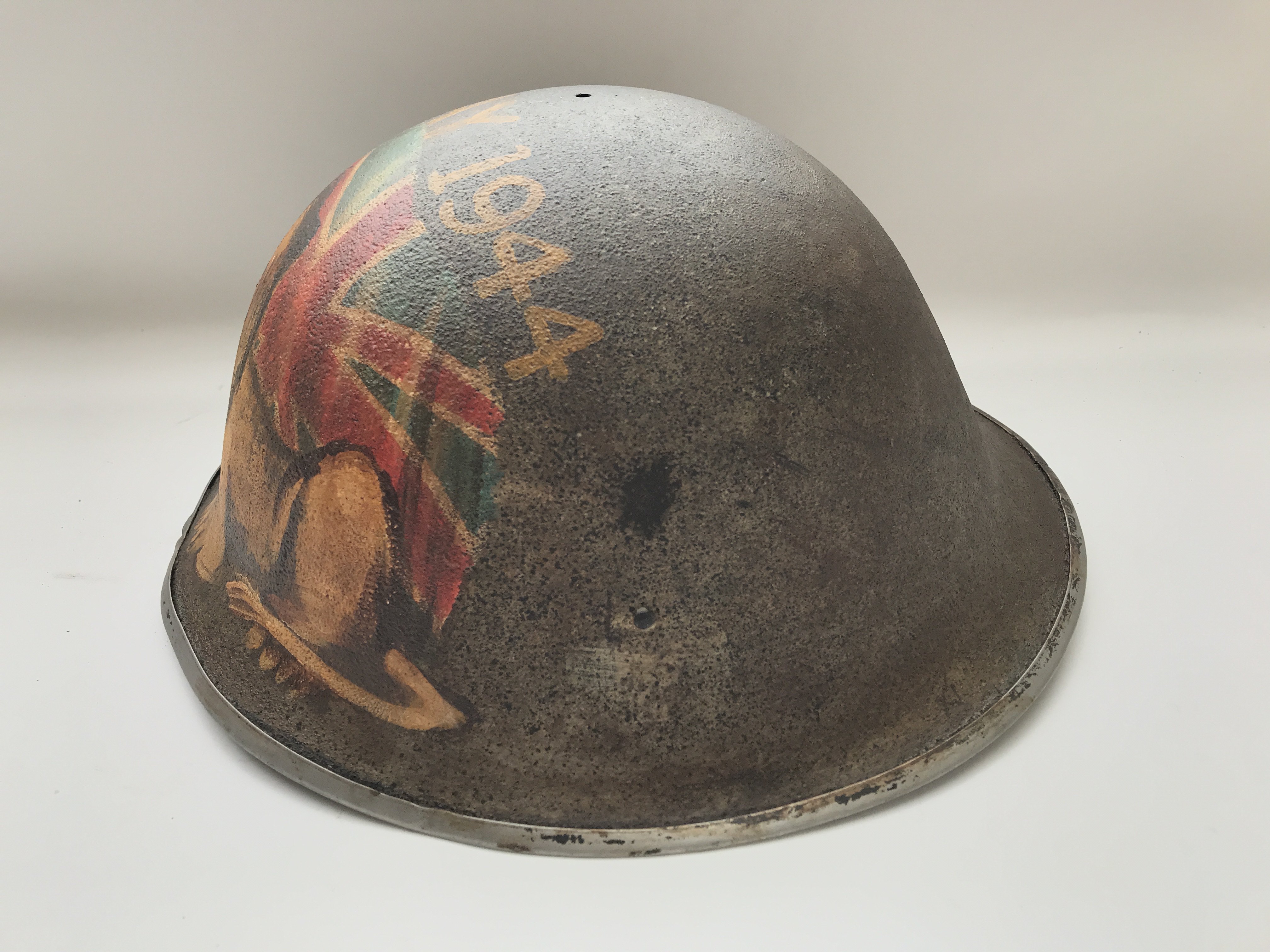 A WW2 British 1944 "turtle" D-Day helmet with post war memorial painting.