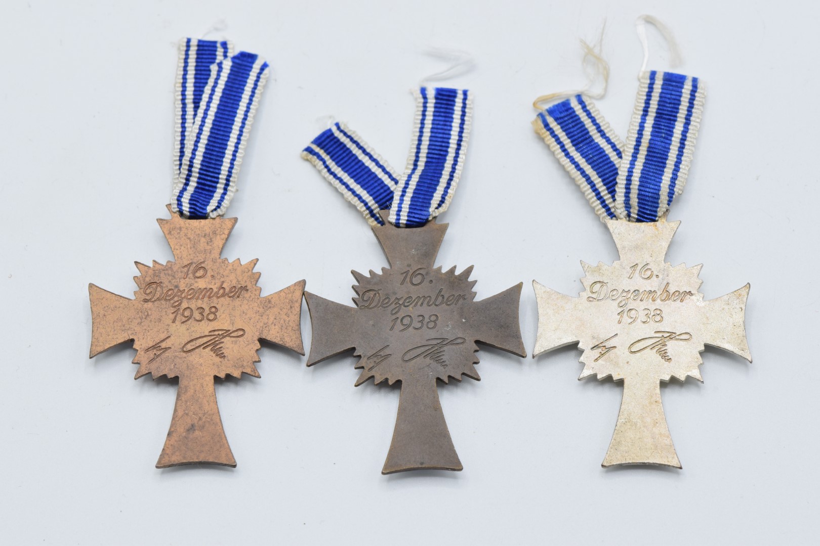 Three German WW2 Third Reich Nazi Mother's Cross Medals comprising gold ...