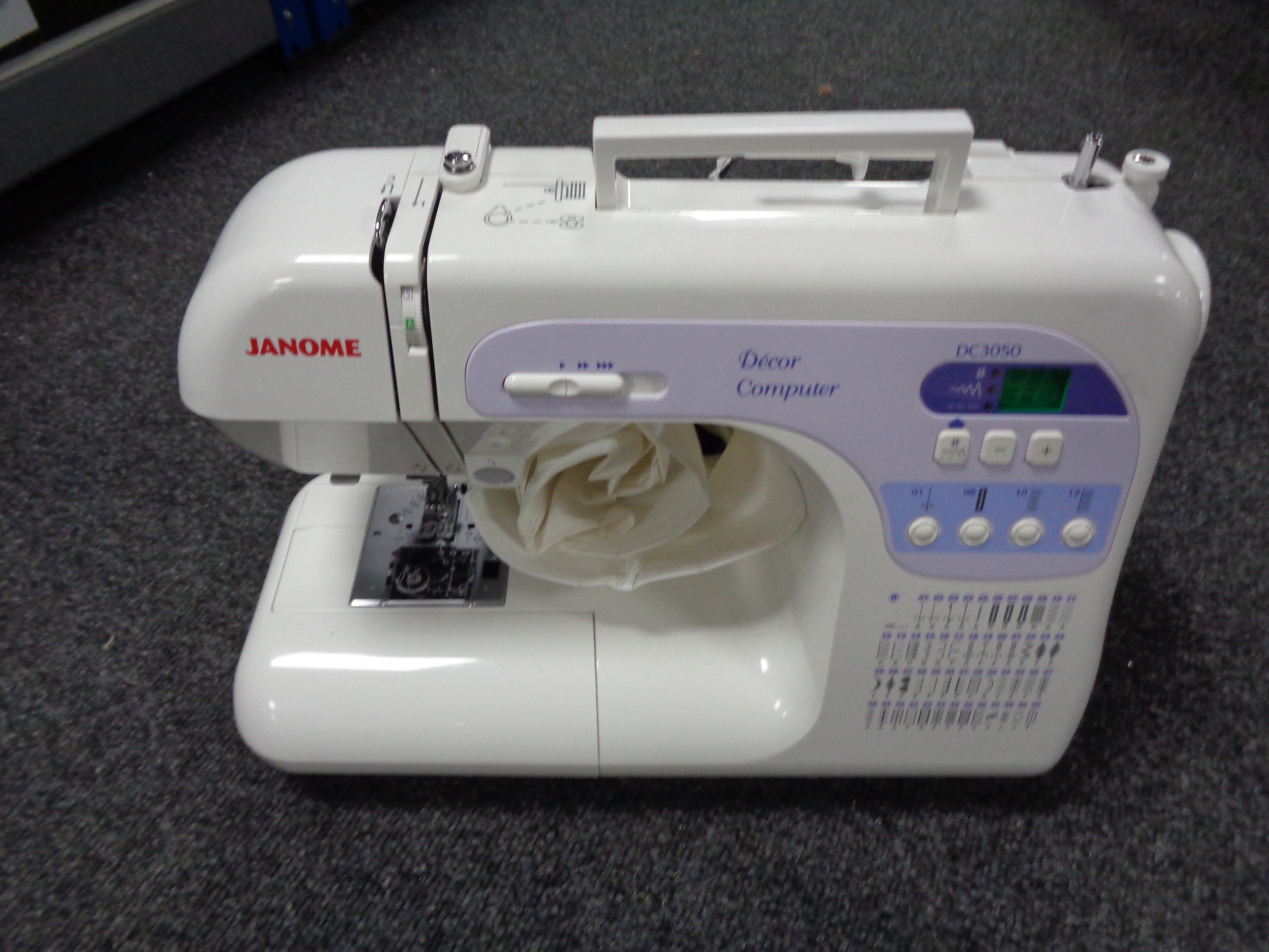 A Janome DC 3050 Decor computer sewing machine with pedal