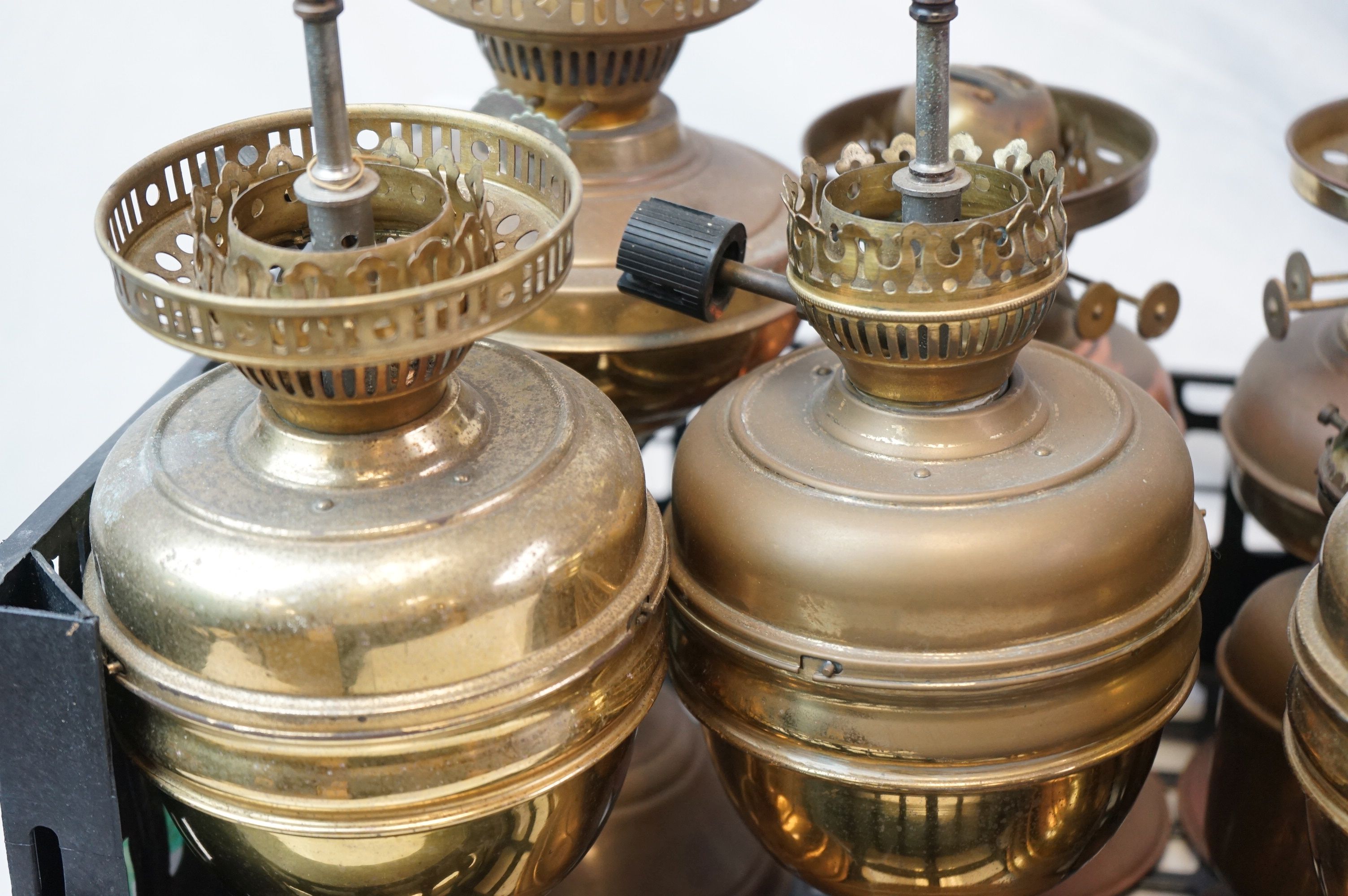 A collection of nine copper and brass oil and gas lamps.