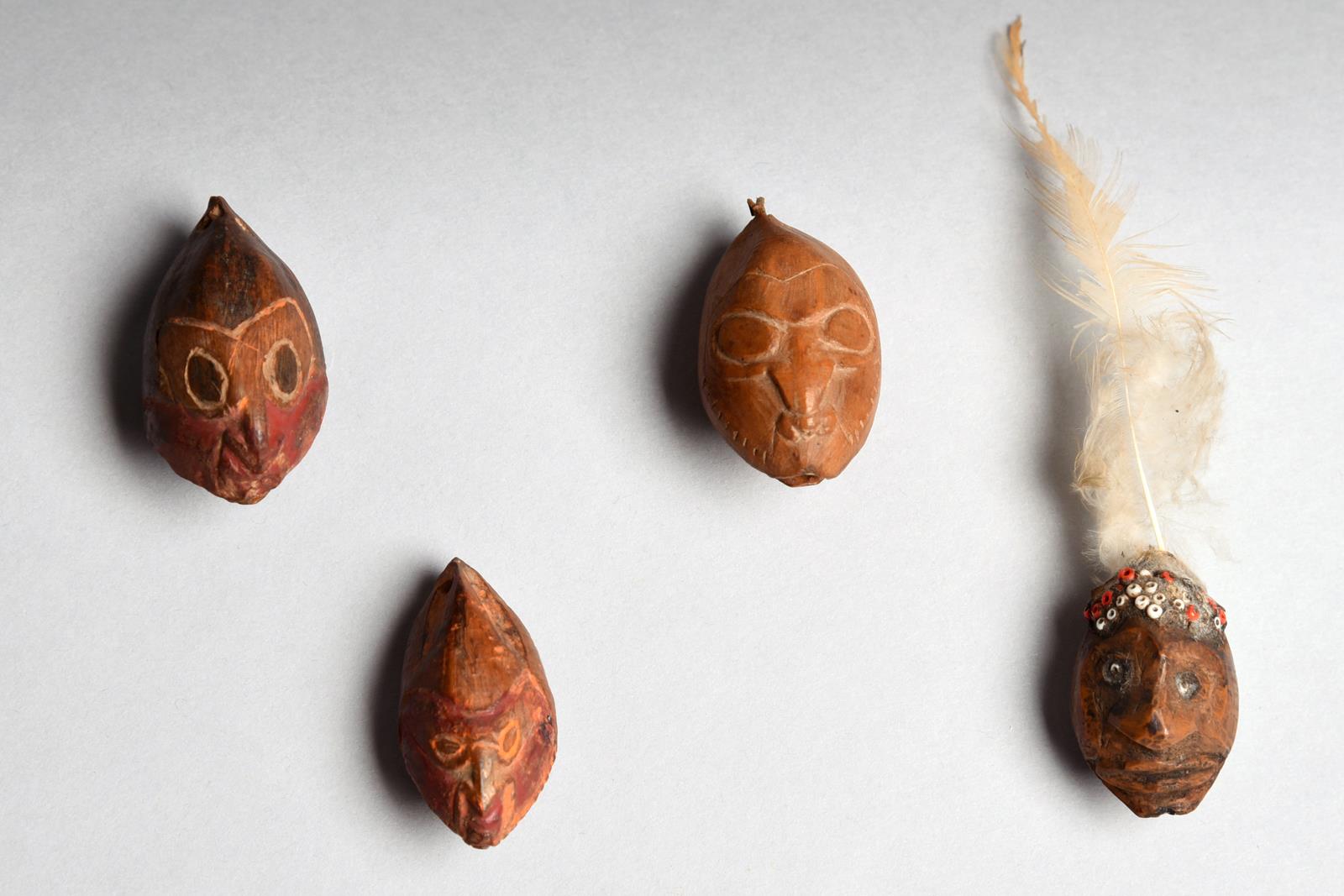 Three Middle Sepik amulets Papua New Guinea galip nut with carved ...